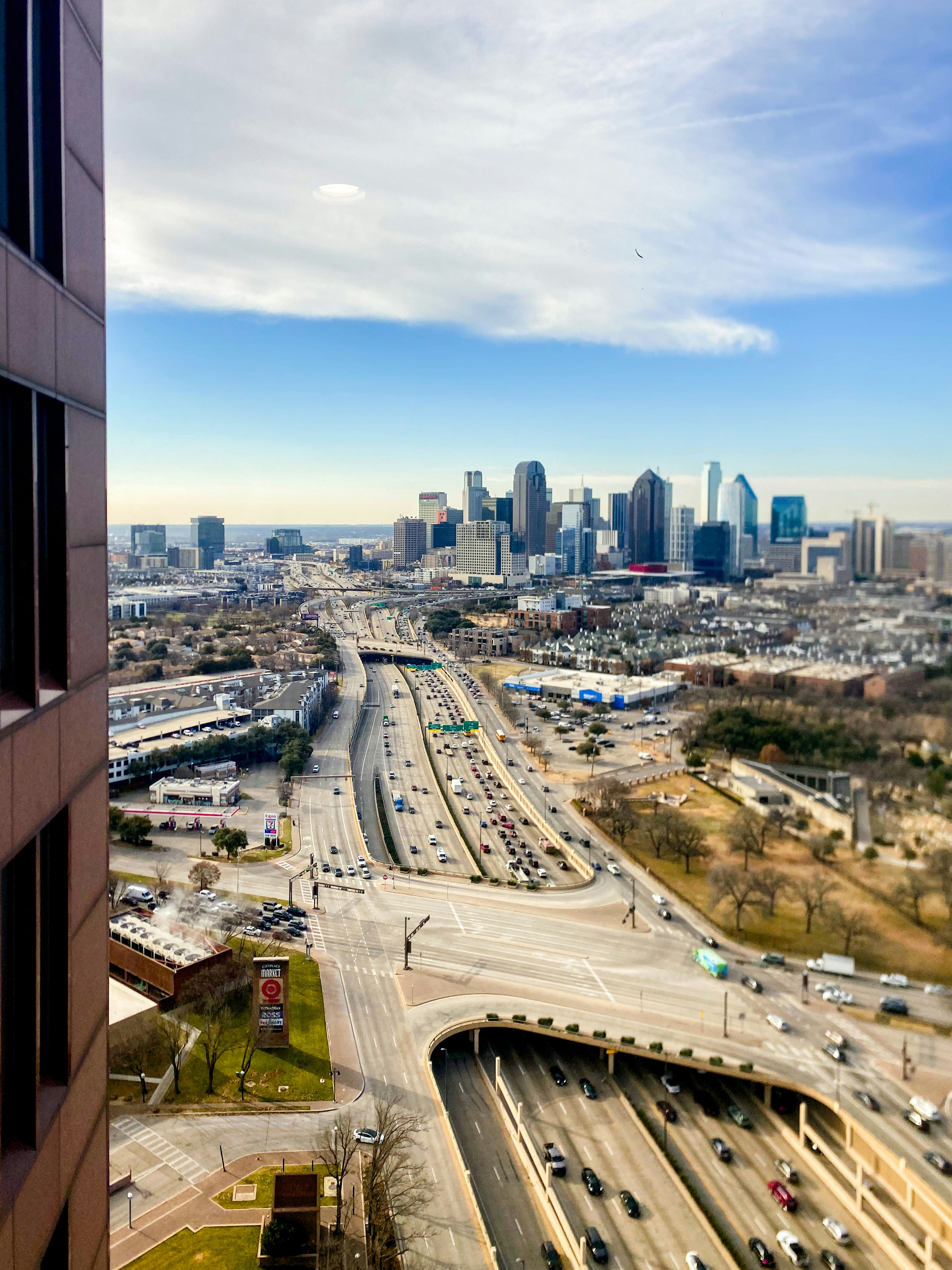 Urban Skyline Arrival: Aerial View Over Freeway Ribbons to a Distant Core