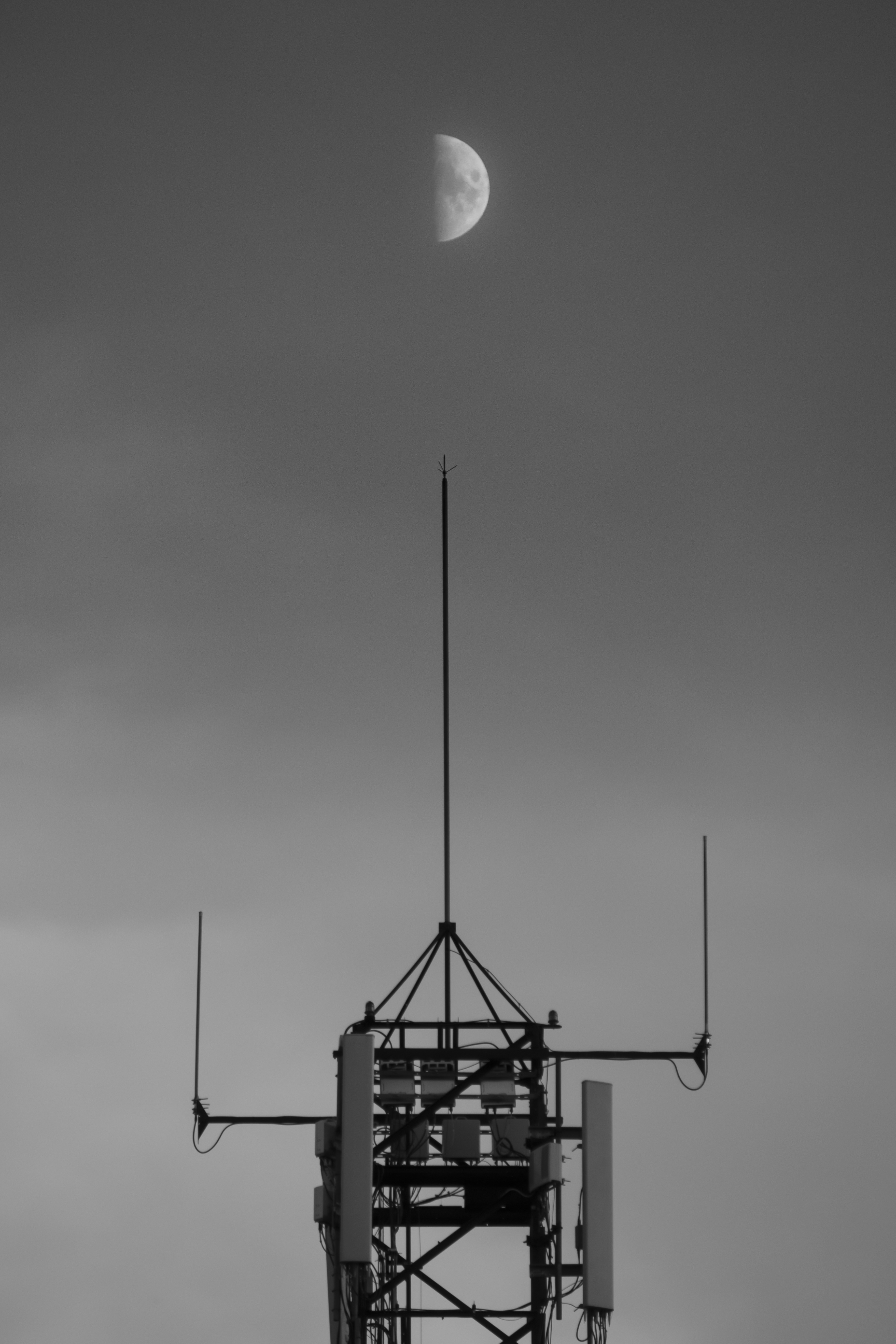 Moon above the communication mast at twilight