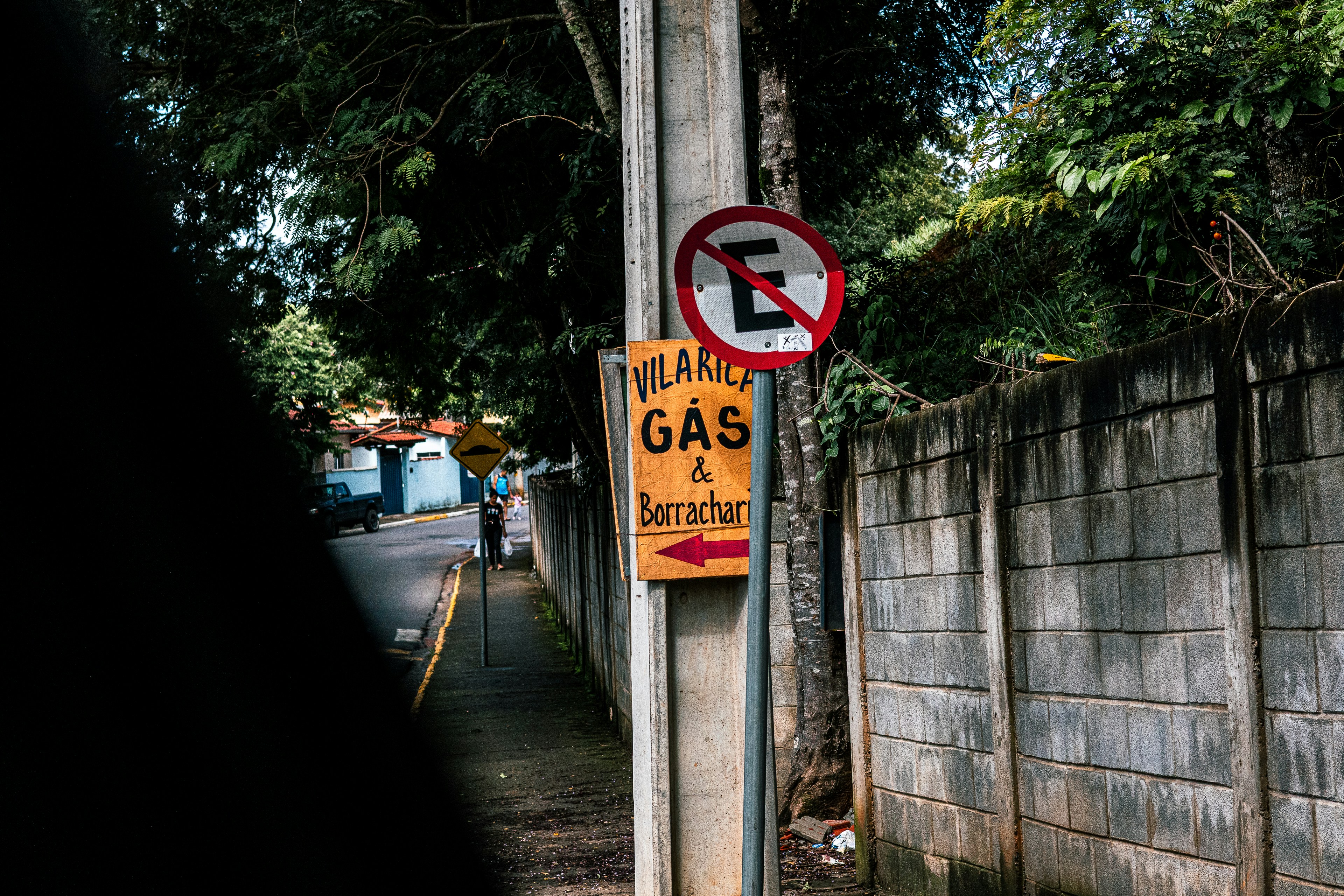 Warning Sign on a Quiet Street Between Concrete Walls