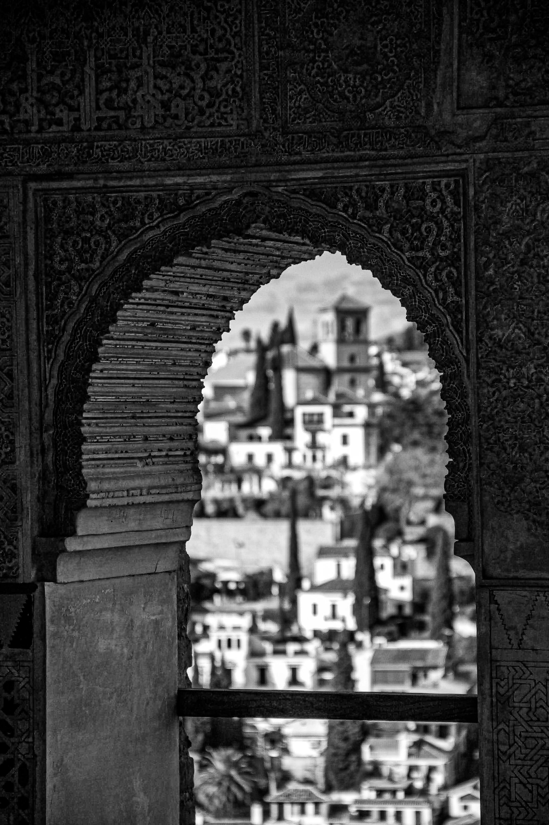 Archway View: A Shrouded City through Stone and Shadow