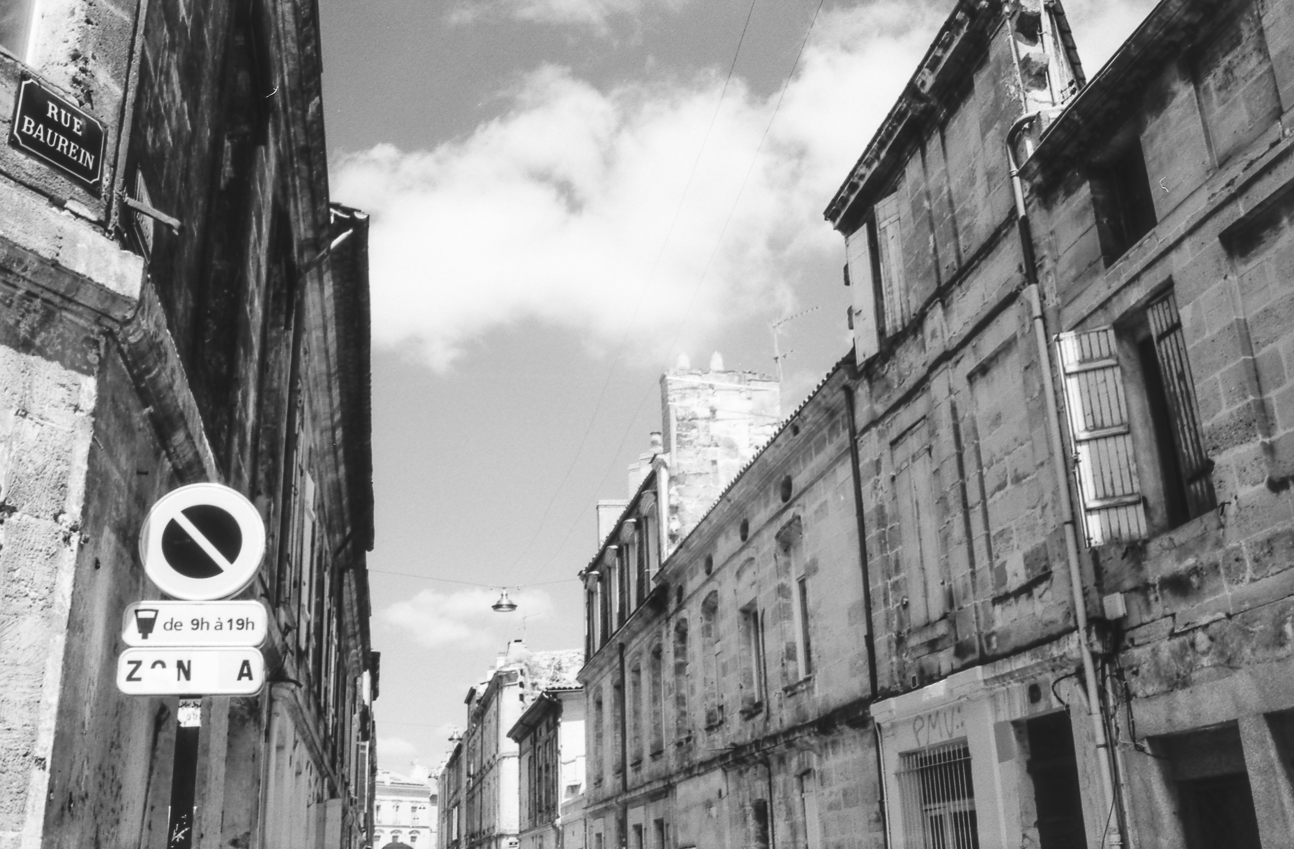Narrow street in monochrome: a city’s quiet edge between old stone and sky
