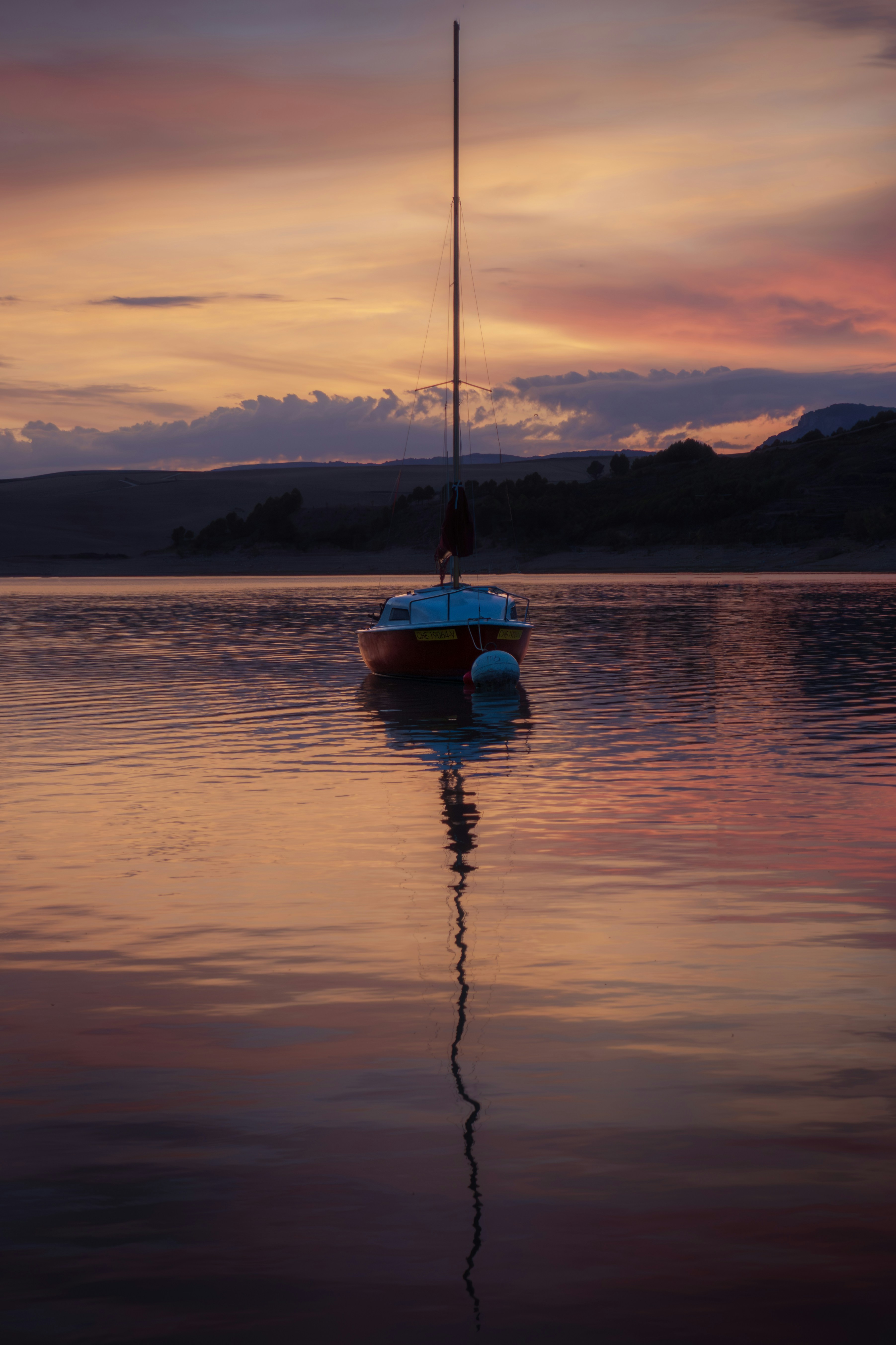 Sailing into the Sunset: A lone boat on tranquil waters