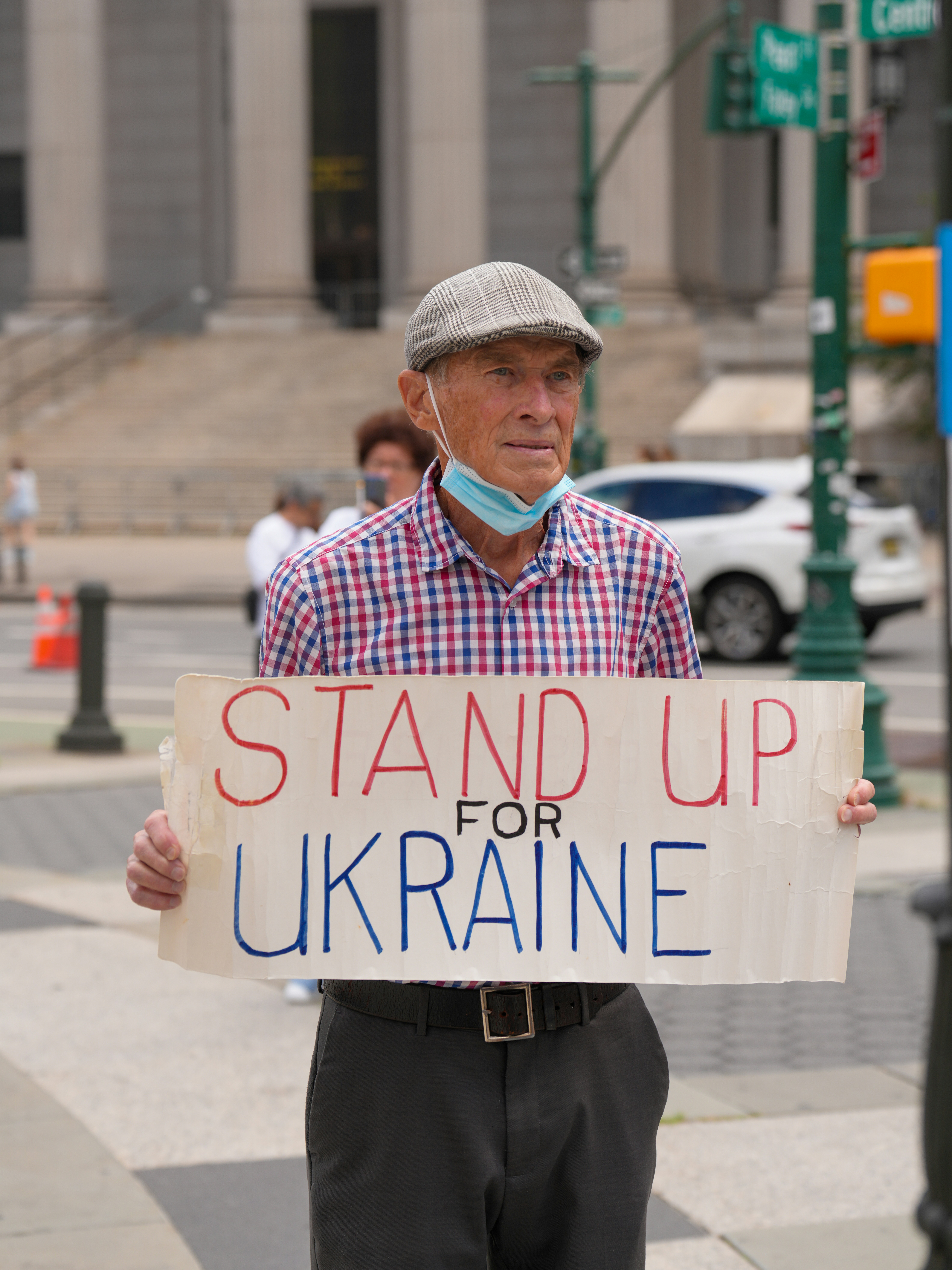 A peaceful New York City rally shows people standing in solidarity with Ukraine, holding blue-and-yellow flags and sharing moments of unity and resilience. Portraits and candid scenes capture emotion, determination, and community spirit. Photographed by Alex Buzunov @buzunov.photoart, this documentary-style image reflects hope, cultural pride, and the power of peaceful voices.