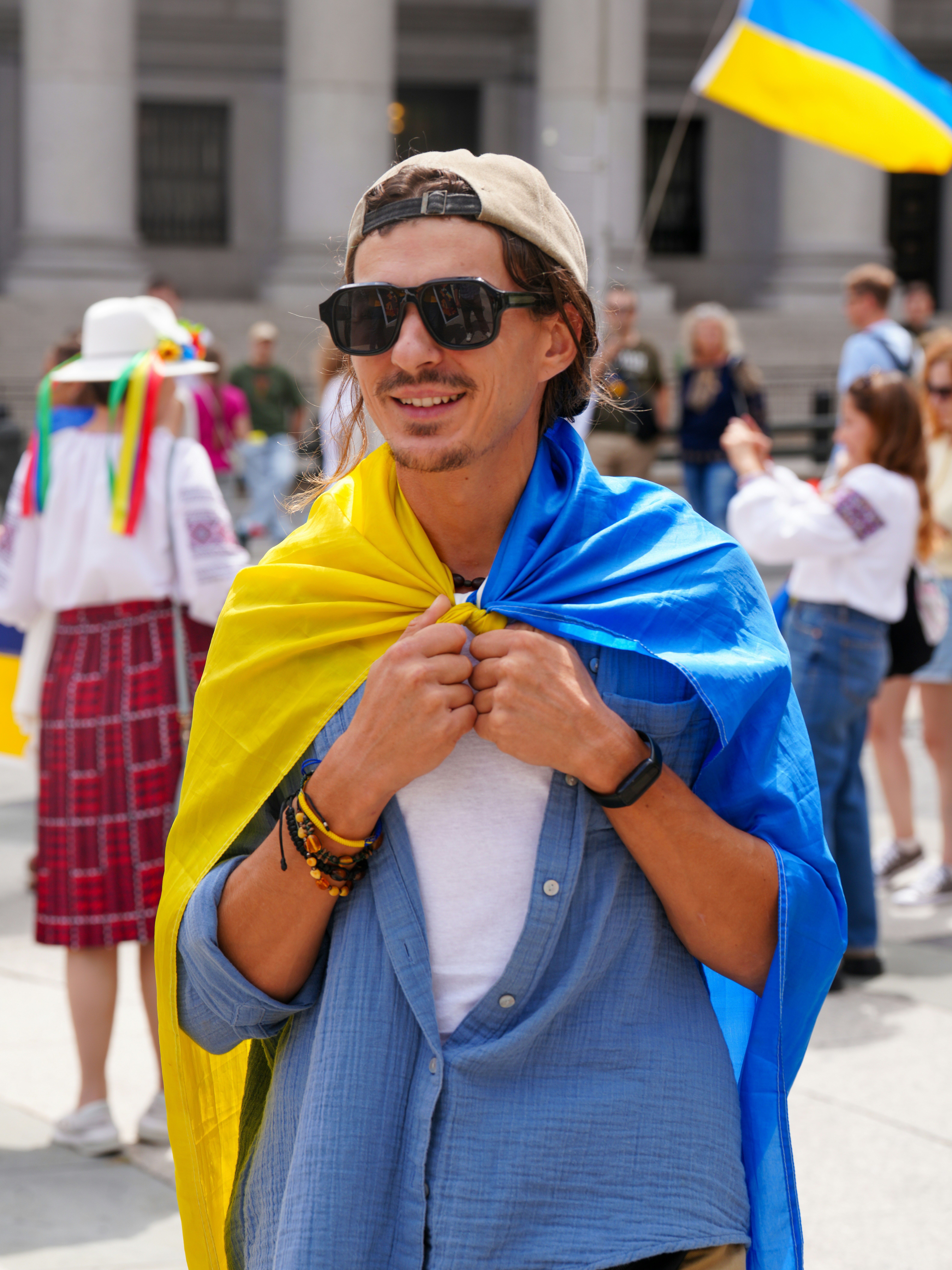 Sunlit Anthem: A Ukrainian Flag Draped Portrait at the City Steps