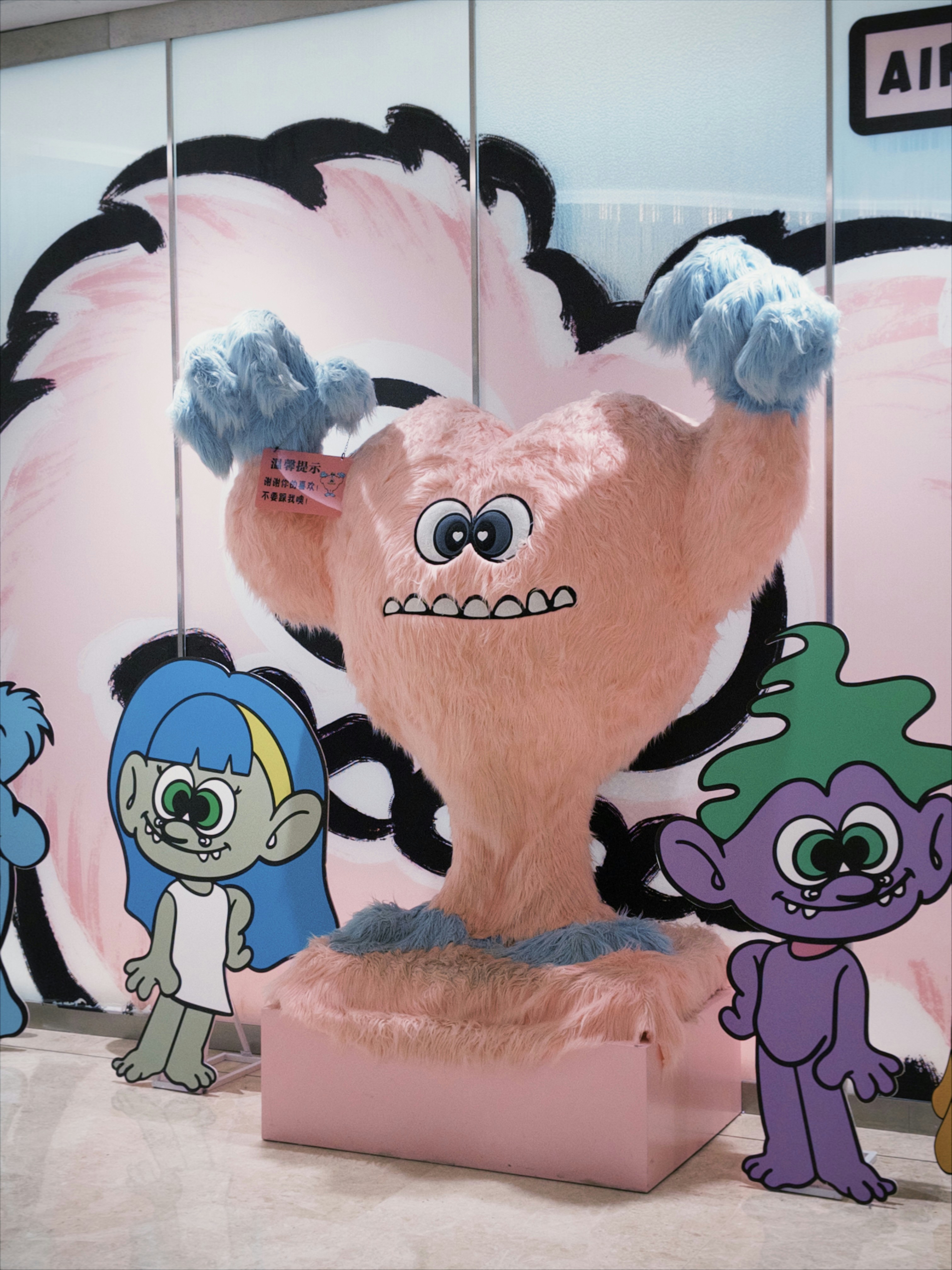 Fluffy pink monster with cartoon trolls