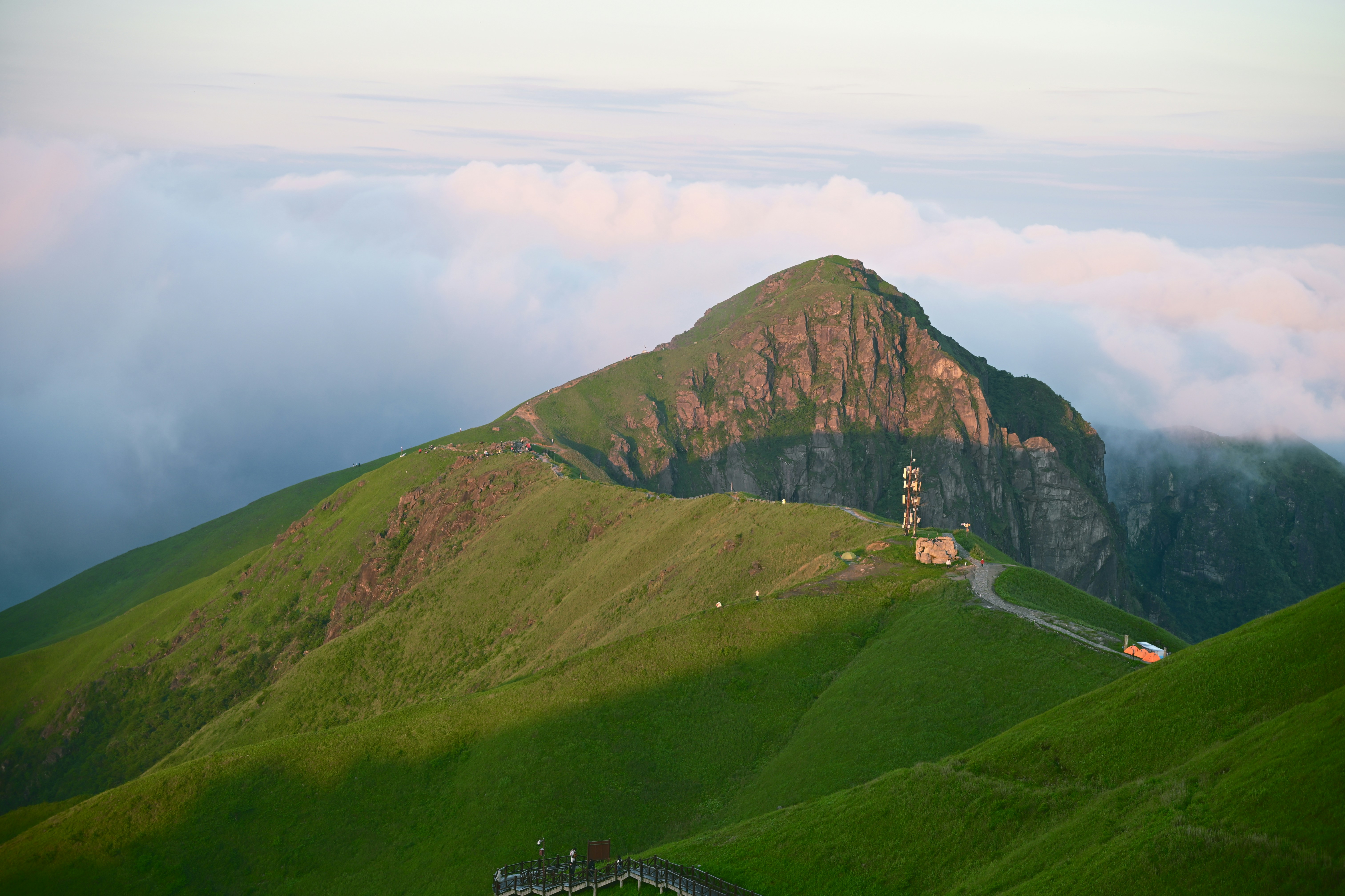 Summit Sentinel: Green Ridge and a Climbing Peak Under Soft Cloud Edge