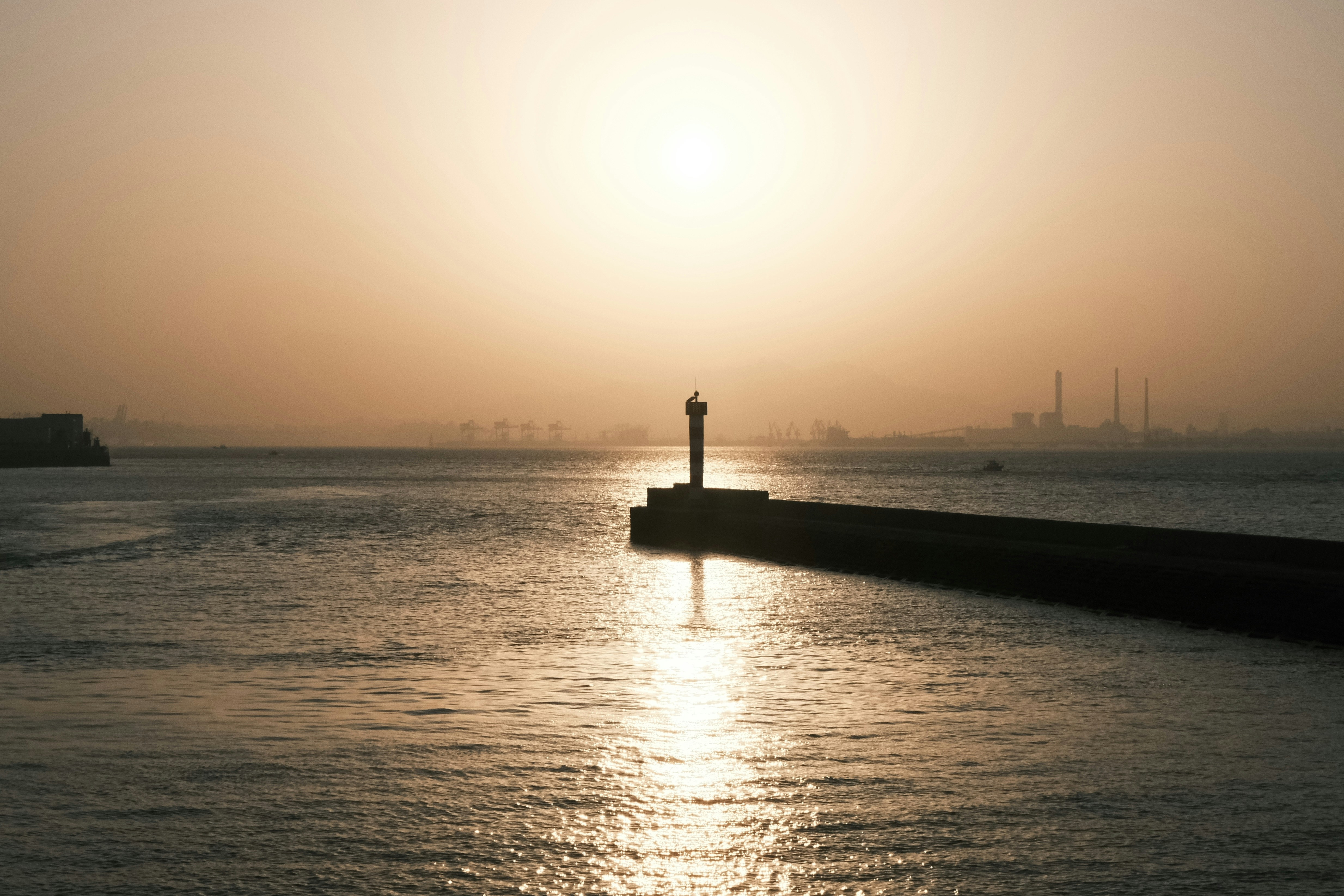 Silhouette at Sunset: A Pier Stretches Toward the Glowing Horizon