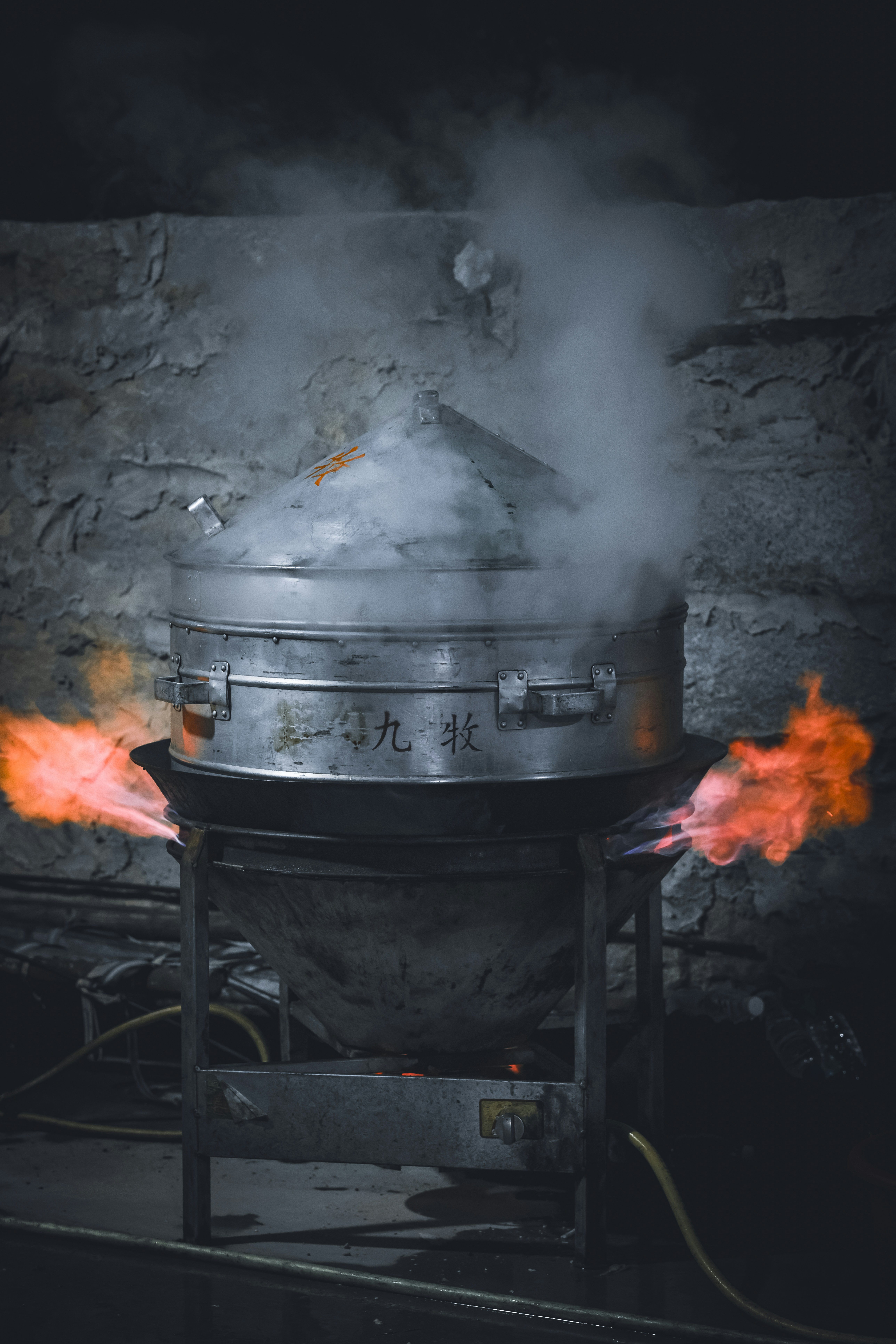 Steaming Iron Pot on a Charcoal Fire: A Workshop of Smoke and Flame