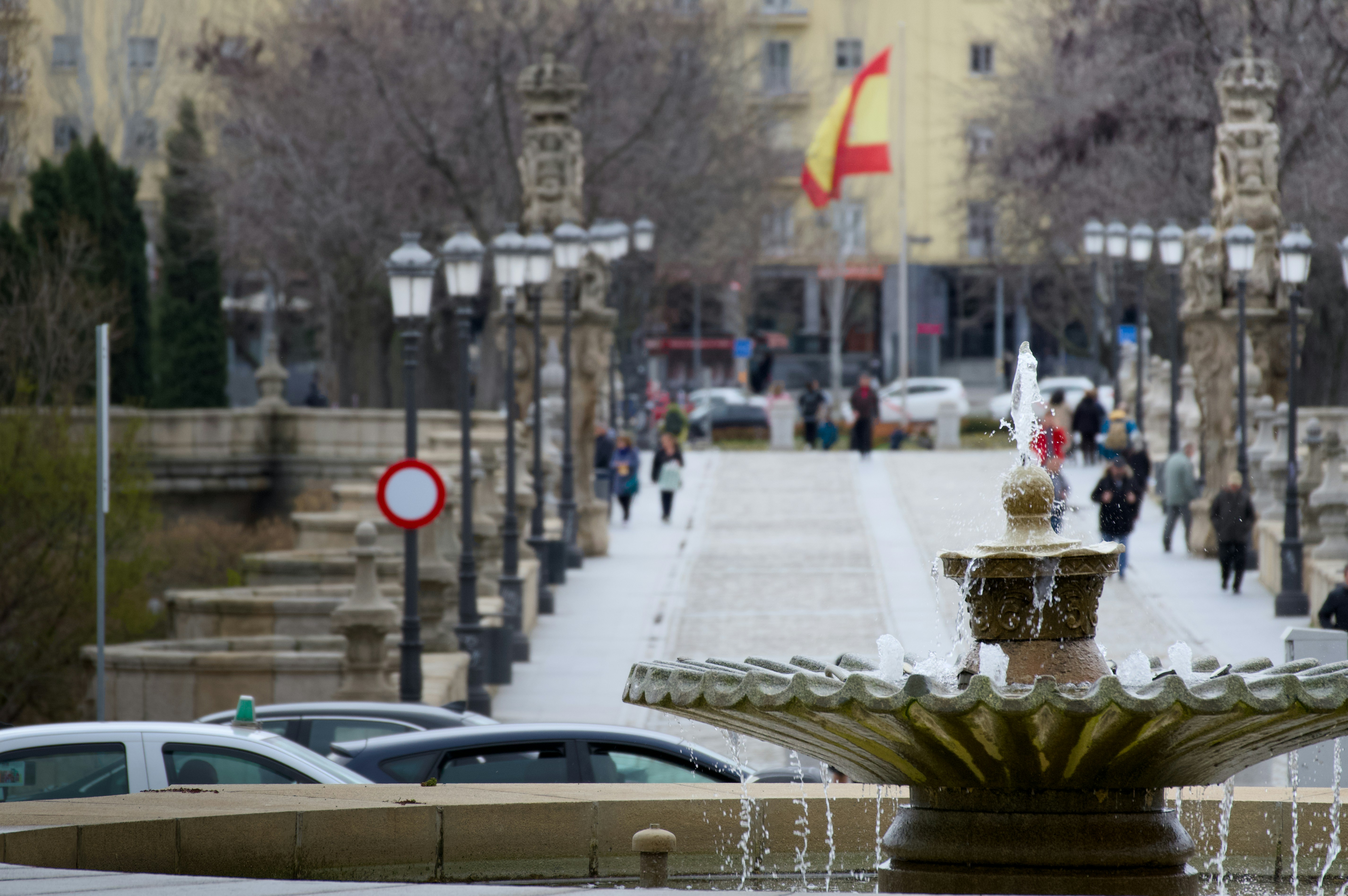Urban Square Fountain Framed by Historic Gateposts