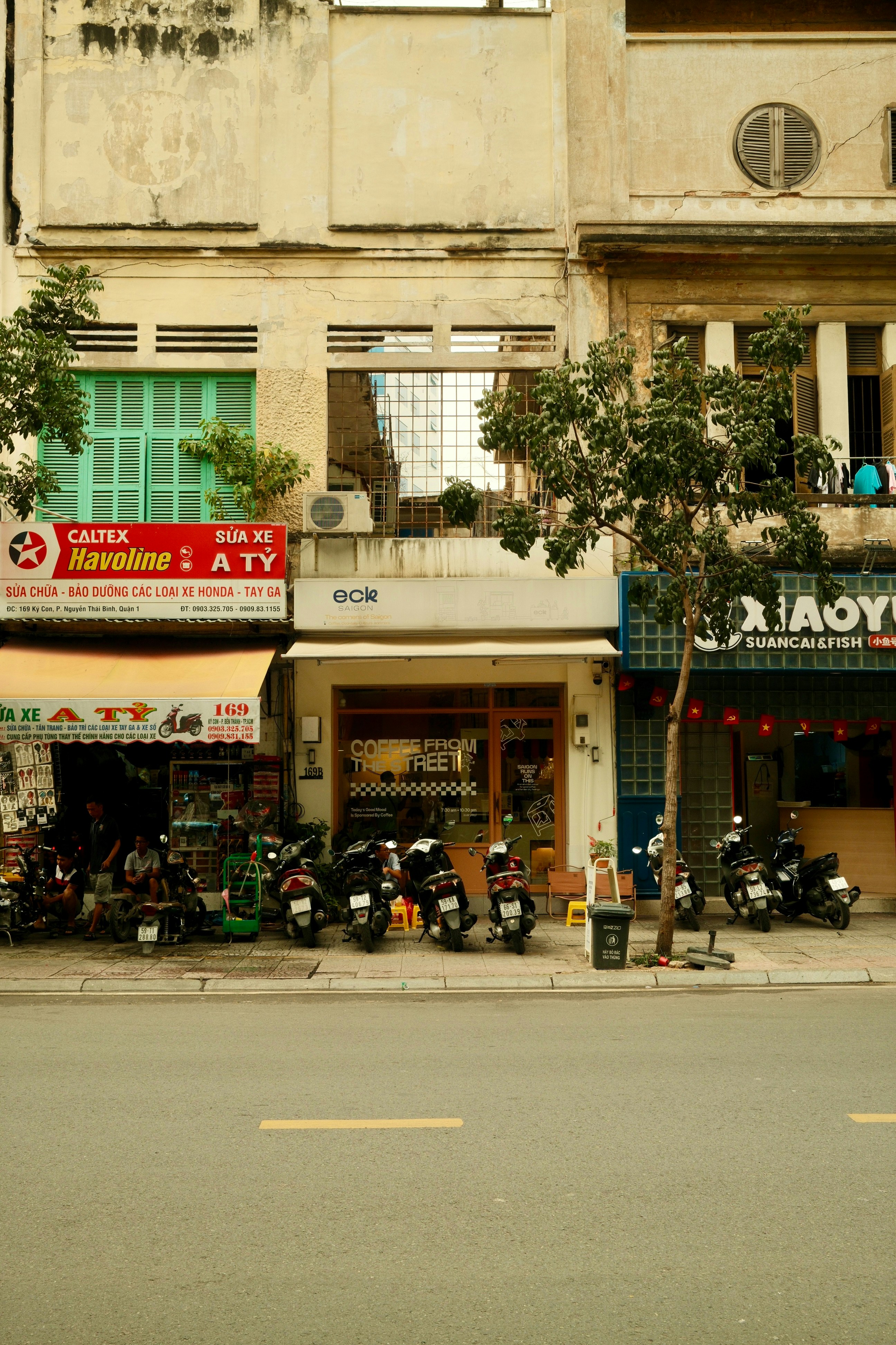 Streetfront Café Chorus: Banners, Scooters, and Sunlit Facades