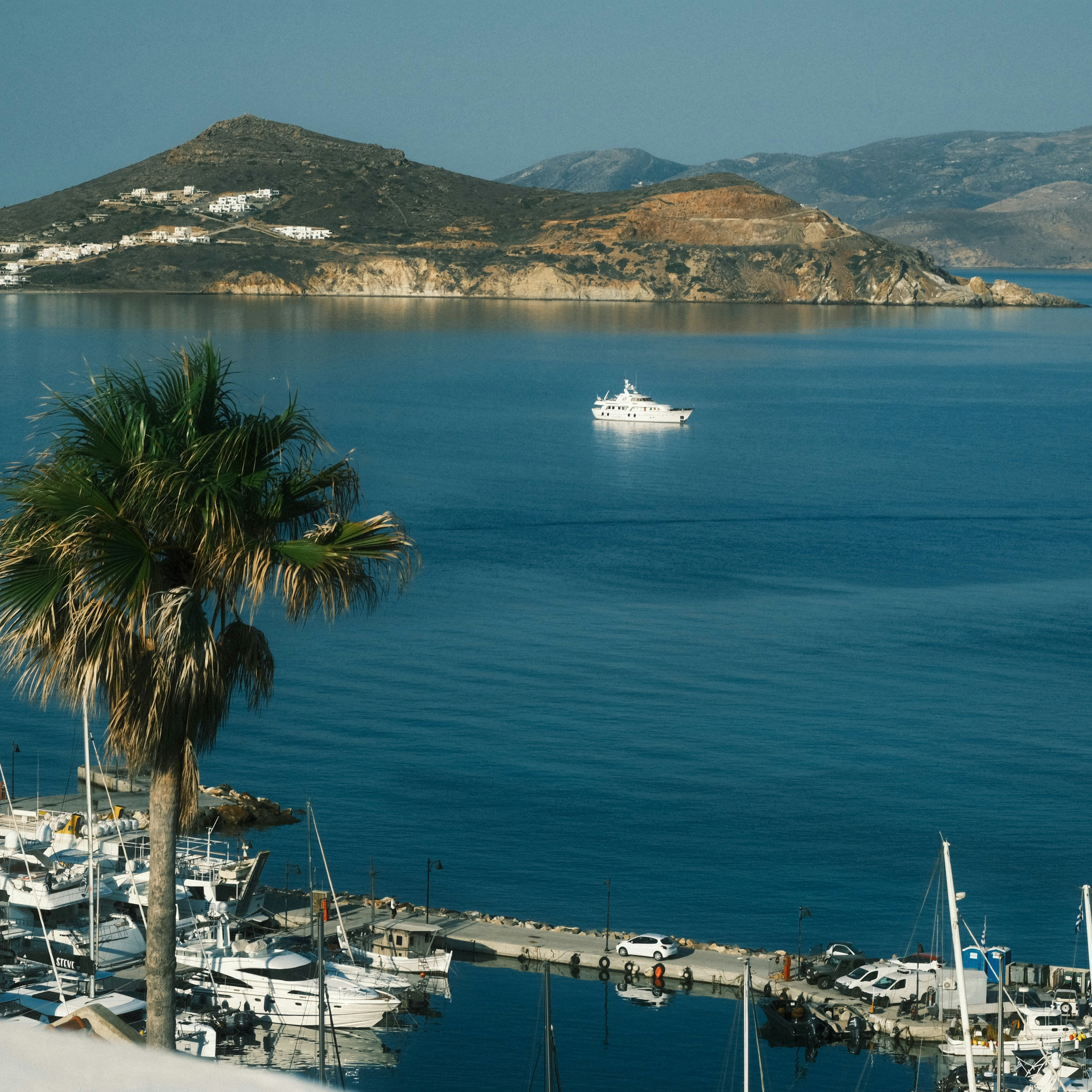 Harbor Quiet: A Coastal Scene with a lone Boat amid Calm Blue Waters