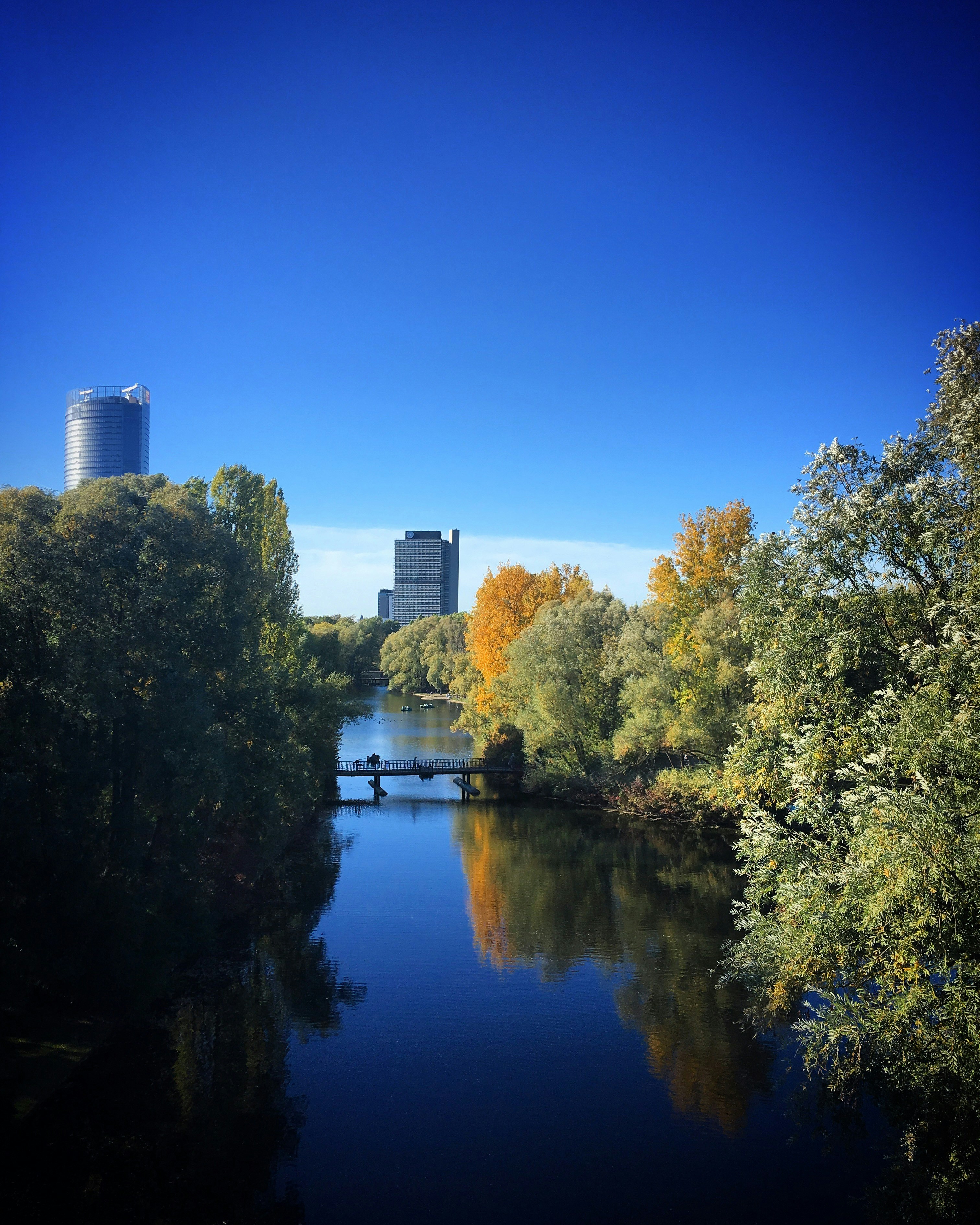 Autumn Canal: Cityscape Reflections Under a Cobalt Sky
