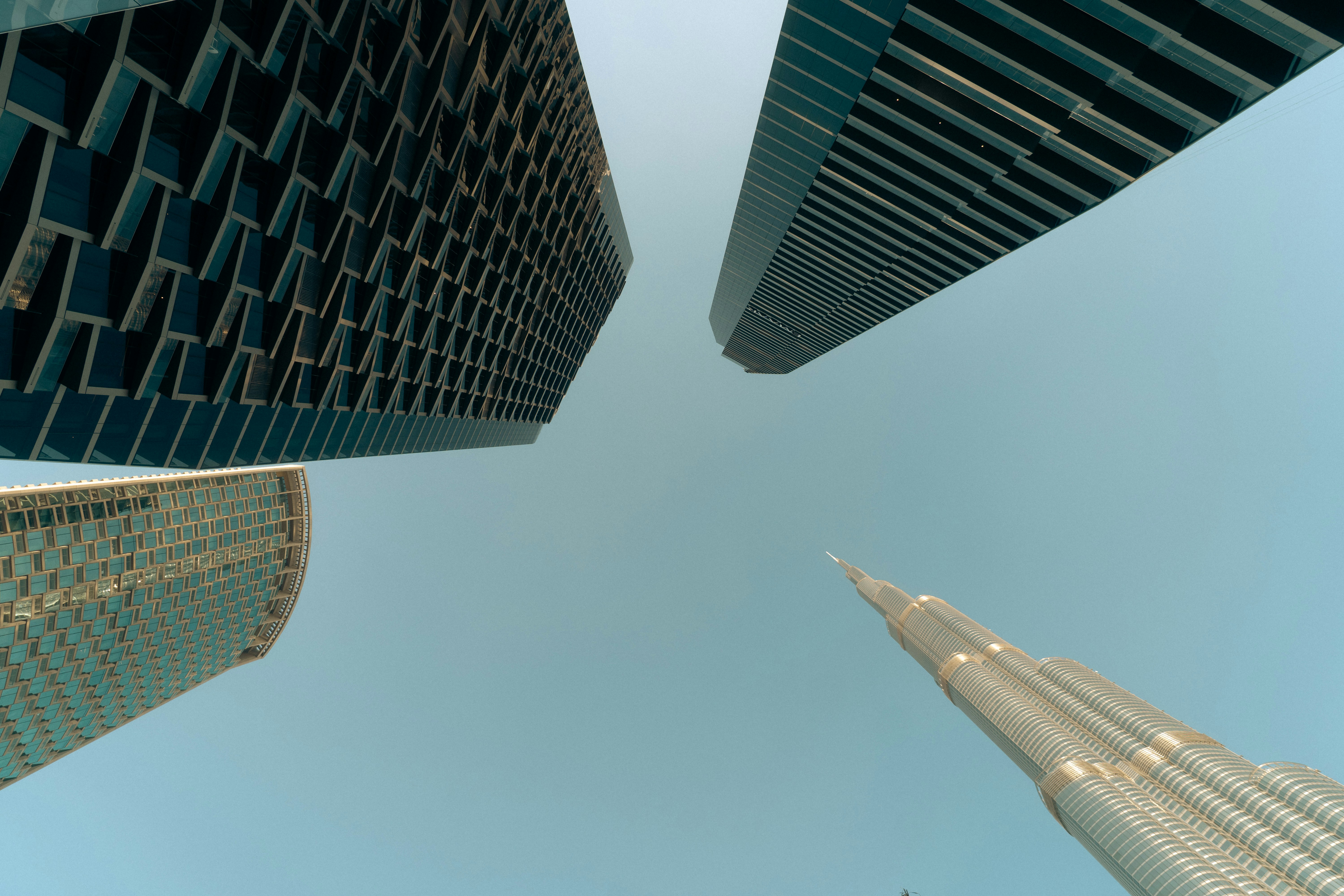 Skyward Convergence: Towers Piercing the Clear Blue