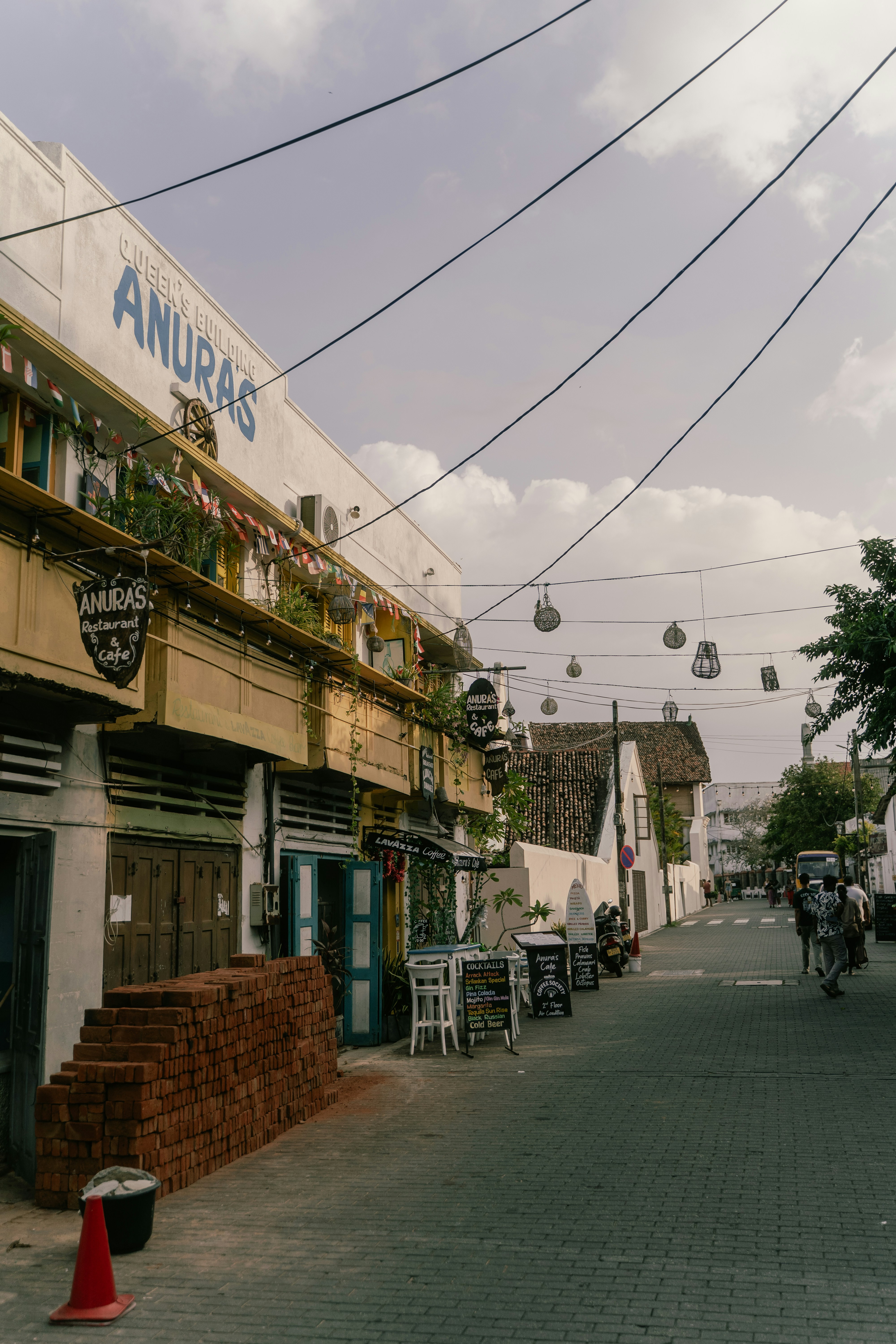 Sunlit Streetfront Cheer at Anuras