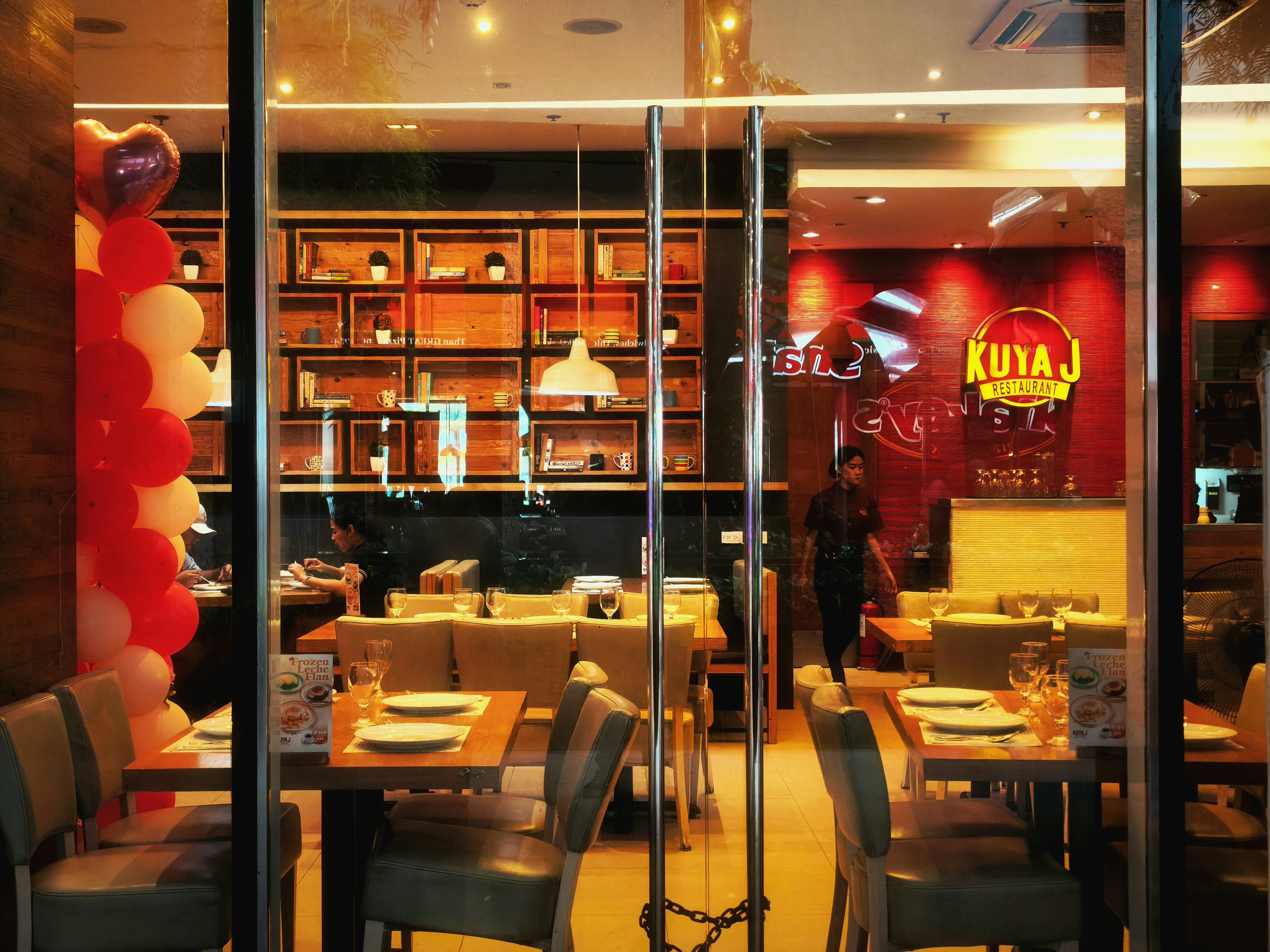 Restaurant interior with tables and chairs ready for diners.