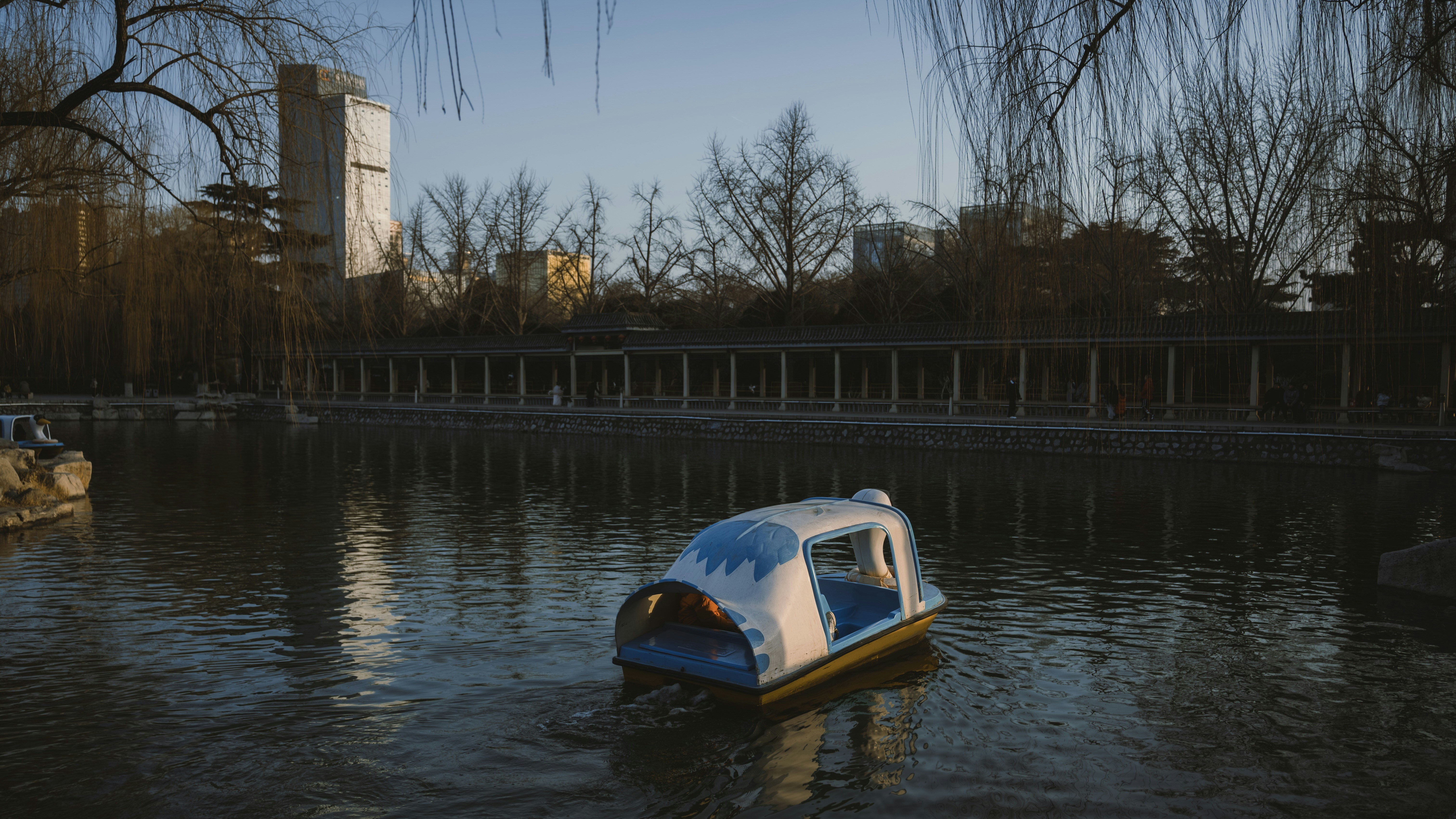 Electric Blue Melodies: The Quiet Boat on a Sunset Lake