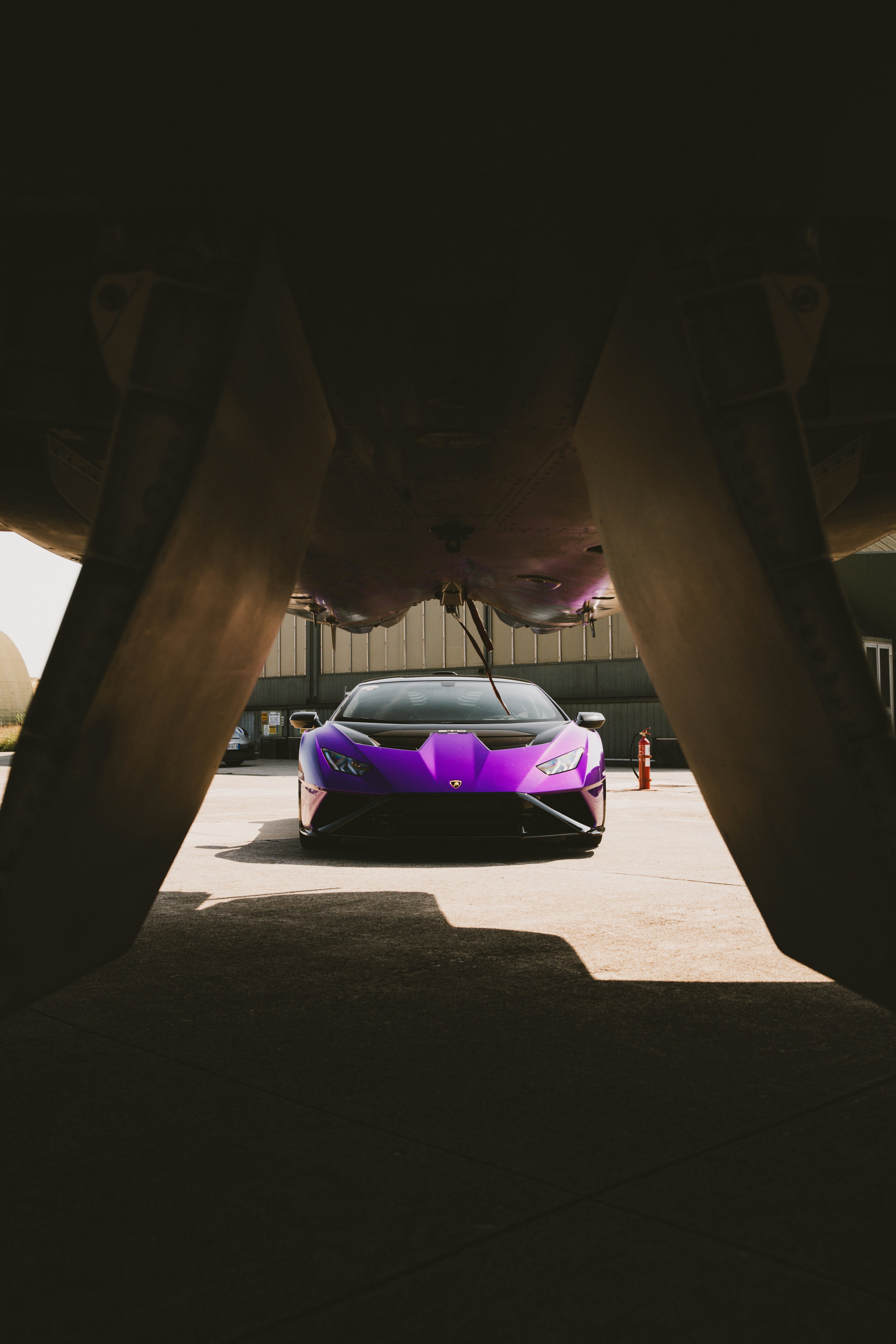 Purple Lamborghini undercarriage: racing glow from between the legs of a giant steel giant