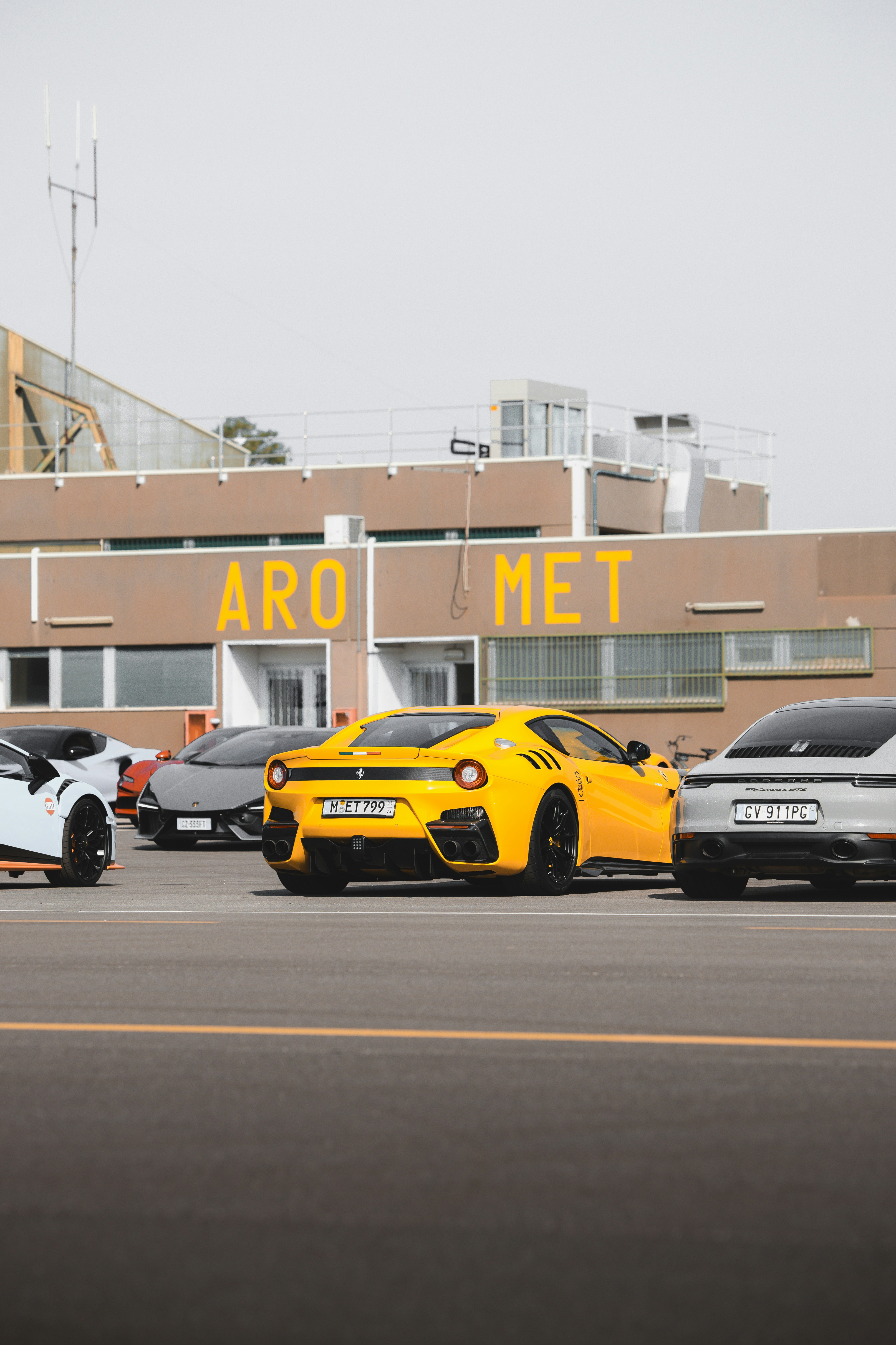 Yellow Ferrari at the Gate: A Moment Outside the Aro Met Hangar