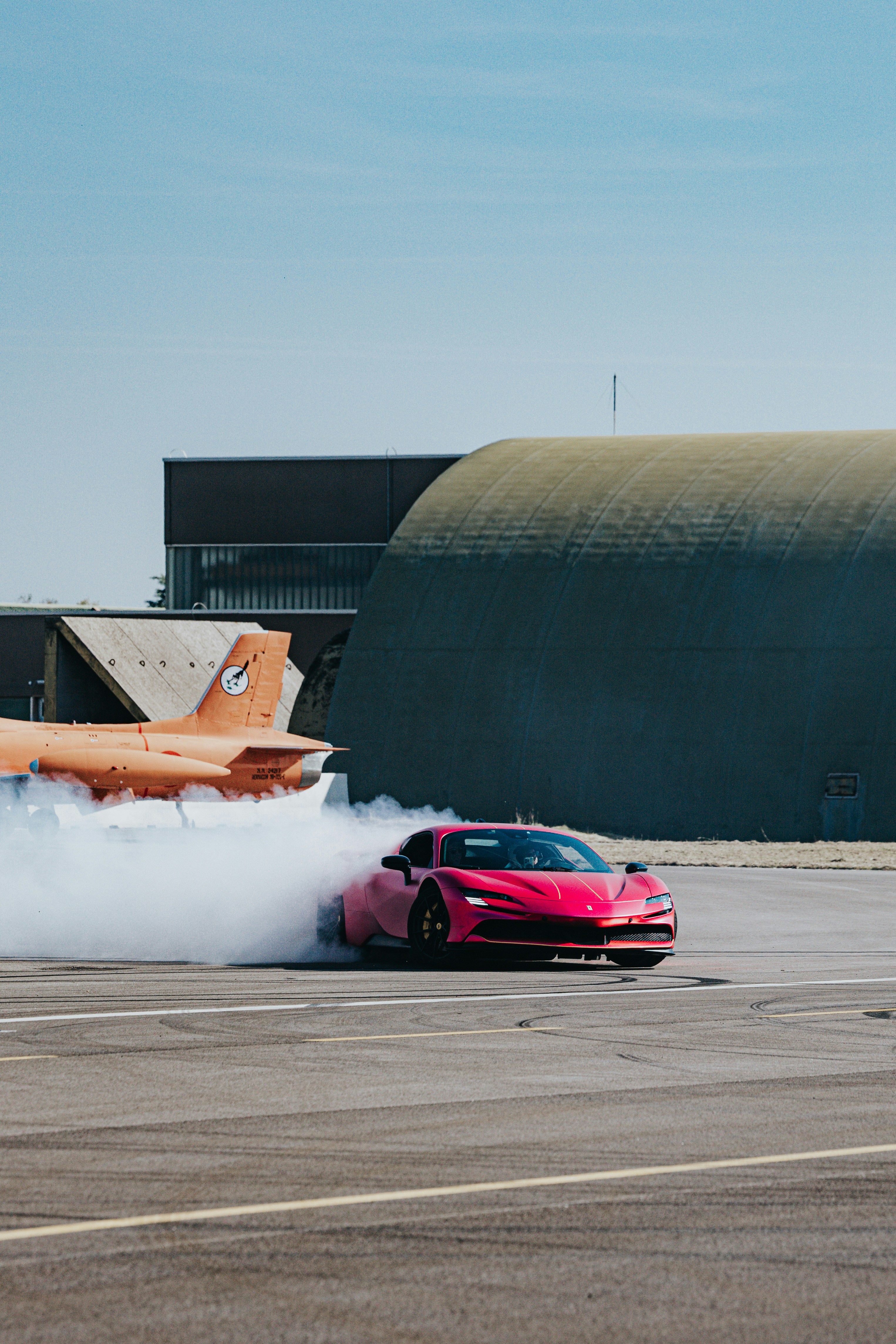 Pink Ferrari Drift at an Airfield: Smoke, Speed, and Sunset Shadows