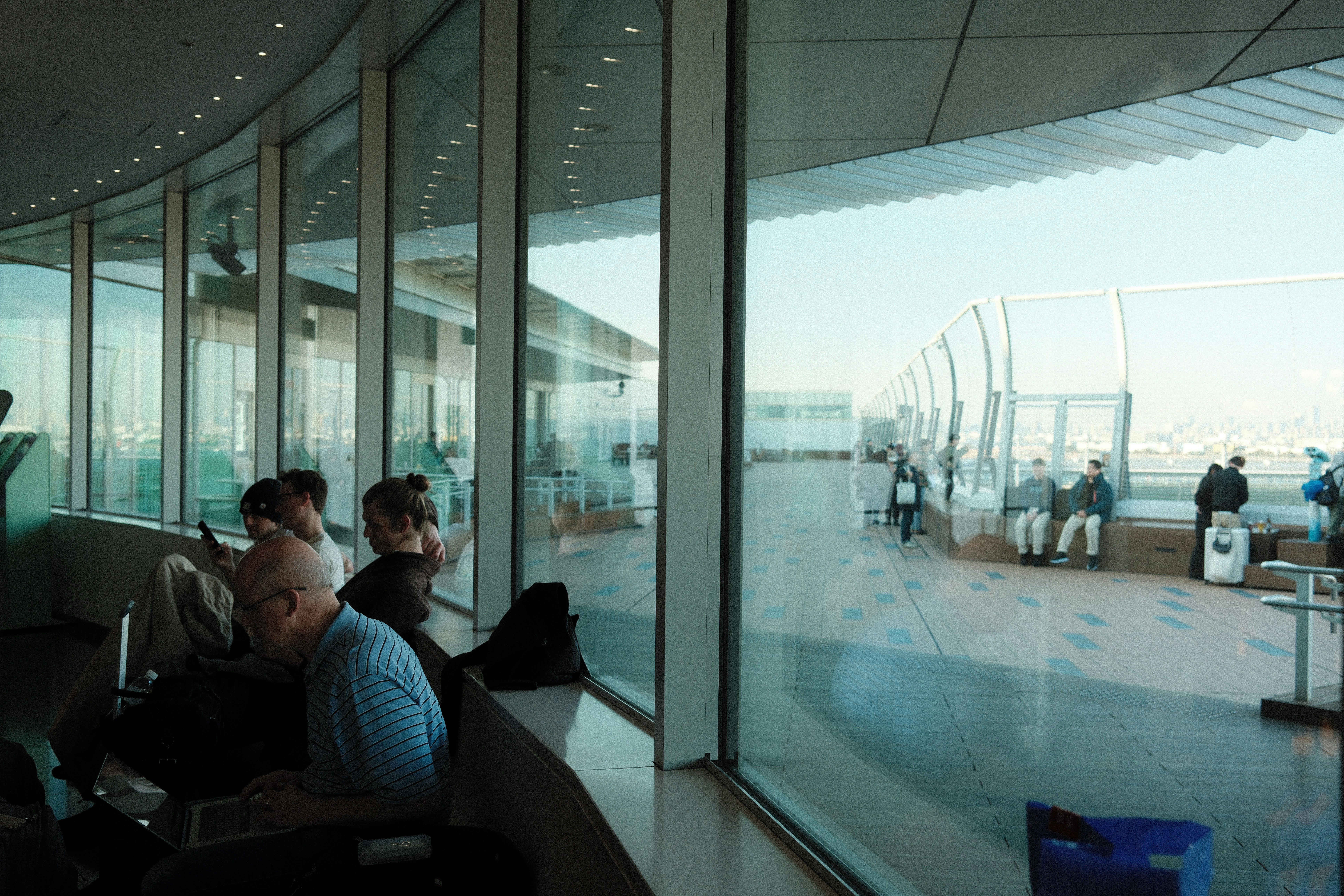 Quiet Gatehouse: Passengers Rest Between Windows