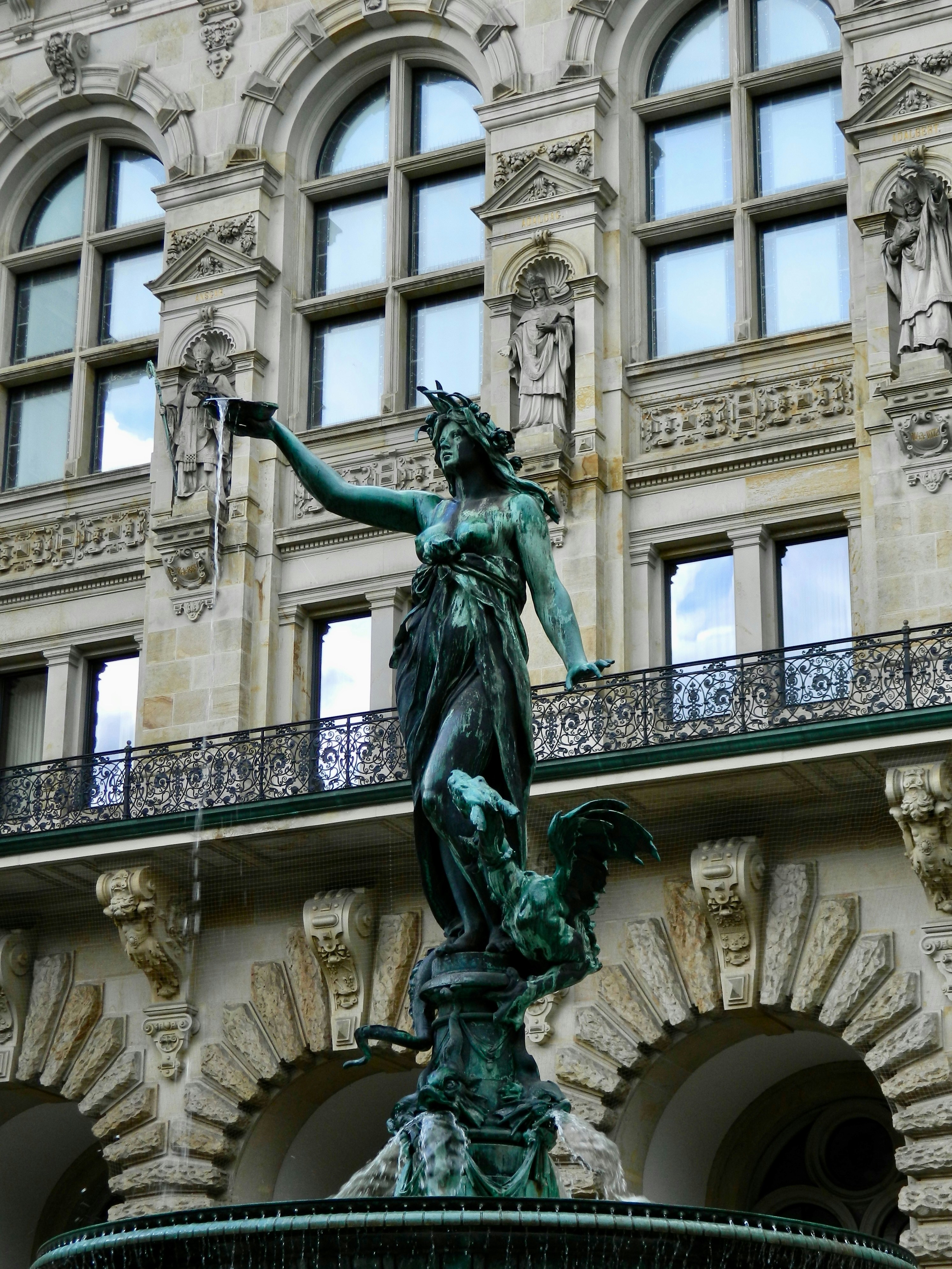Bronze Statue Fountain Confronting the Façade of an Ornate European Building
