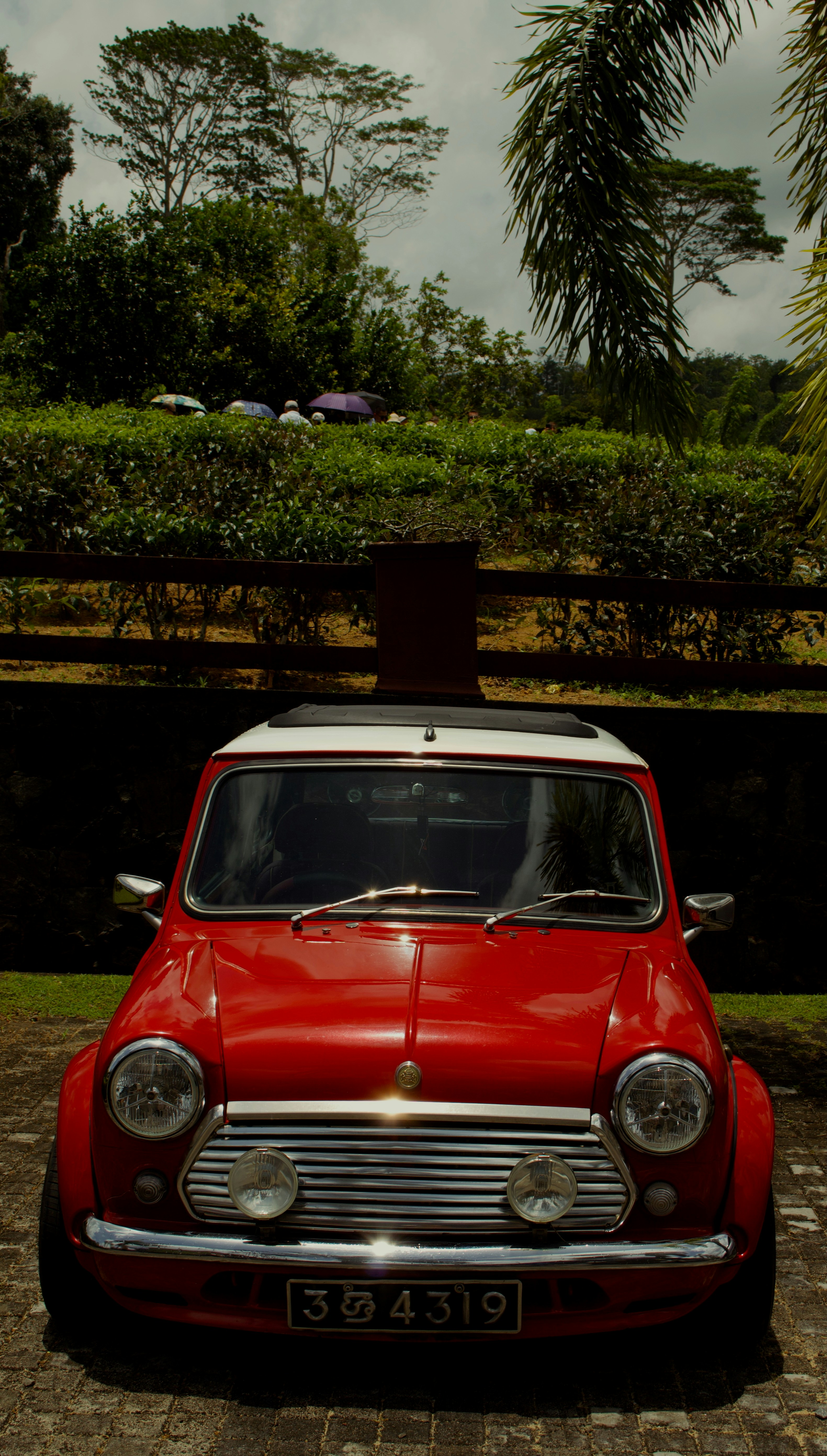 Red Classic Sedan Anchored in Shadowed Courtyard