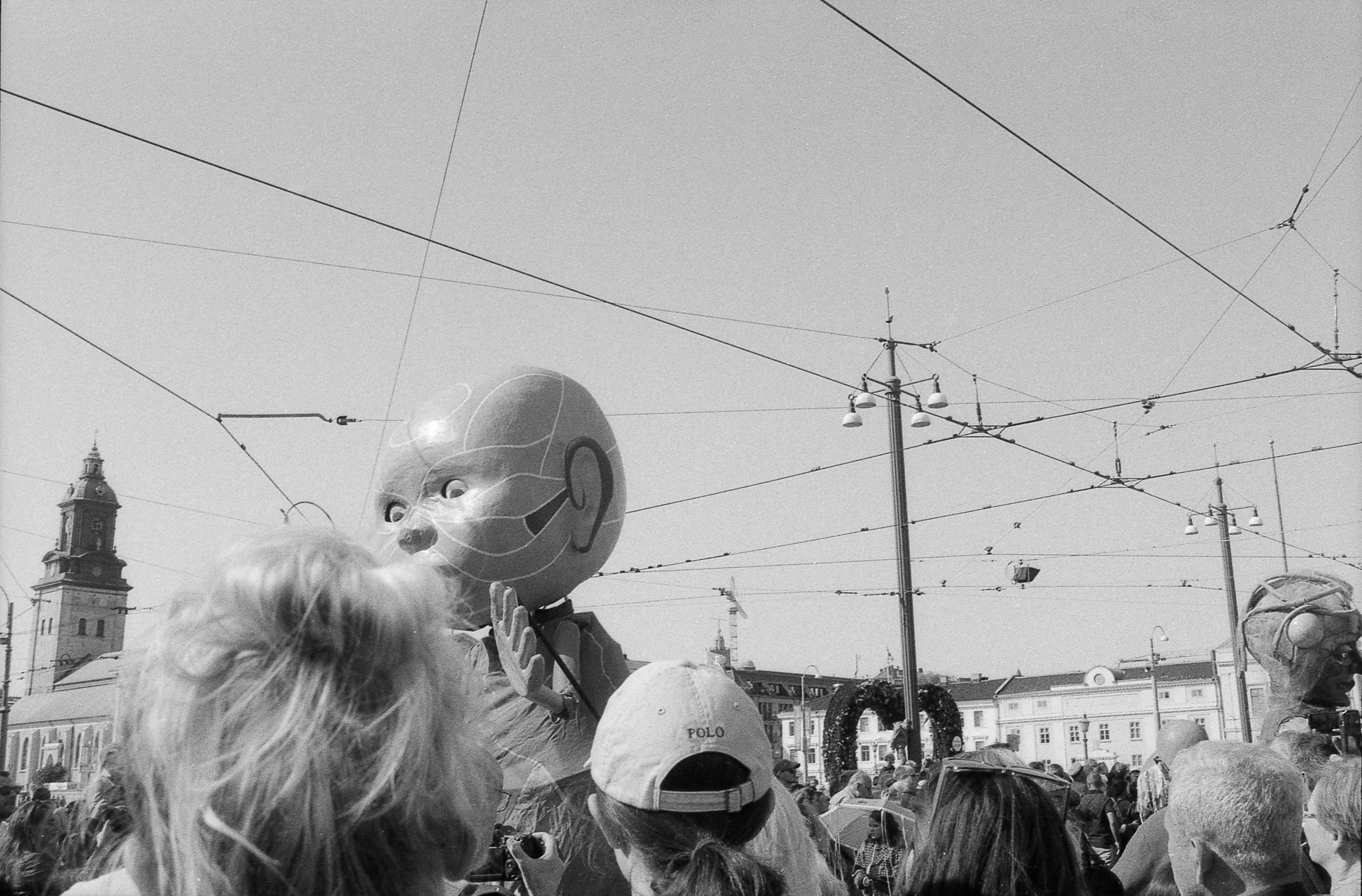 Giant baby doll balloon at a sunny outdoor event