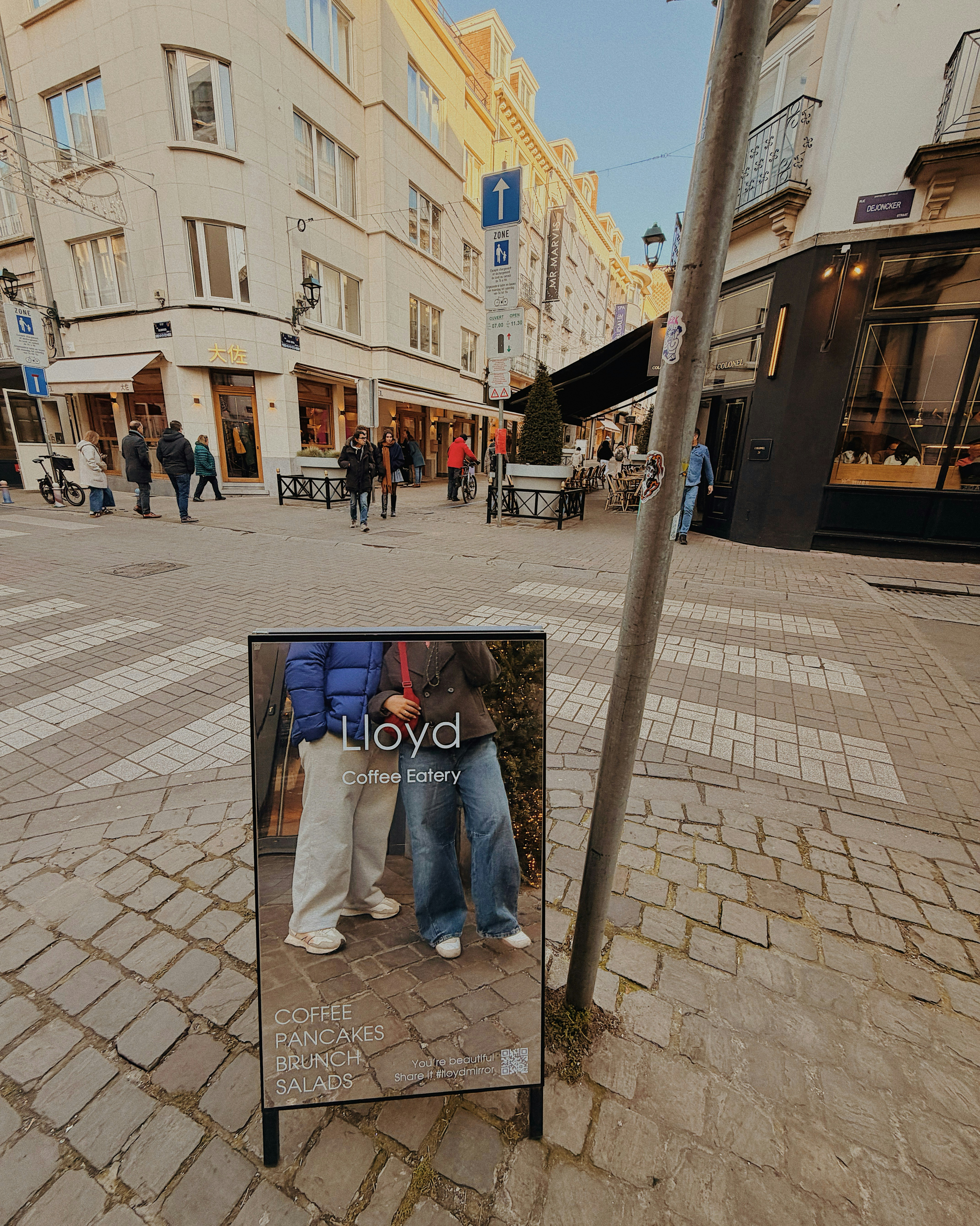 A-frame sign for lloyd coffee eatery on cobblestone street