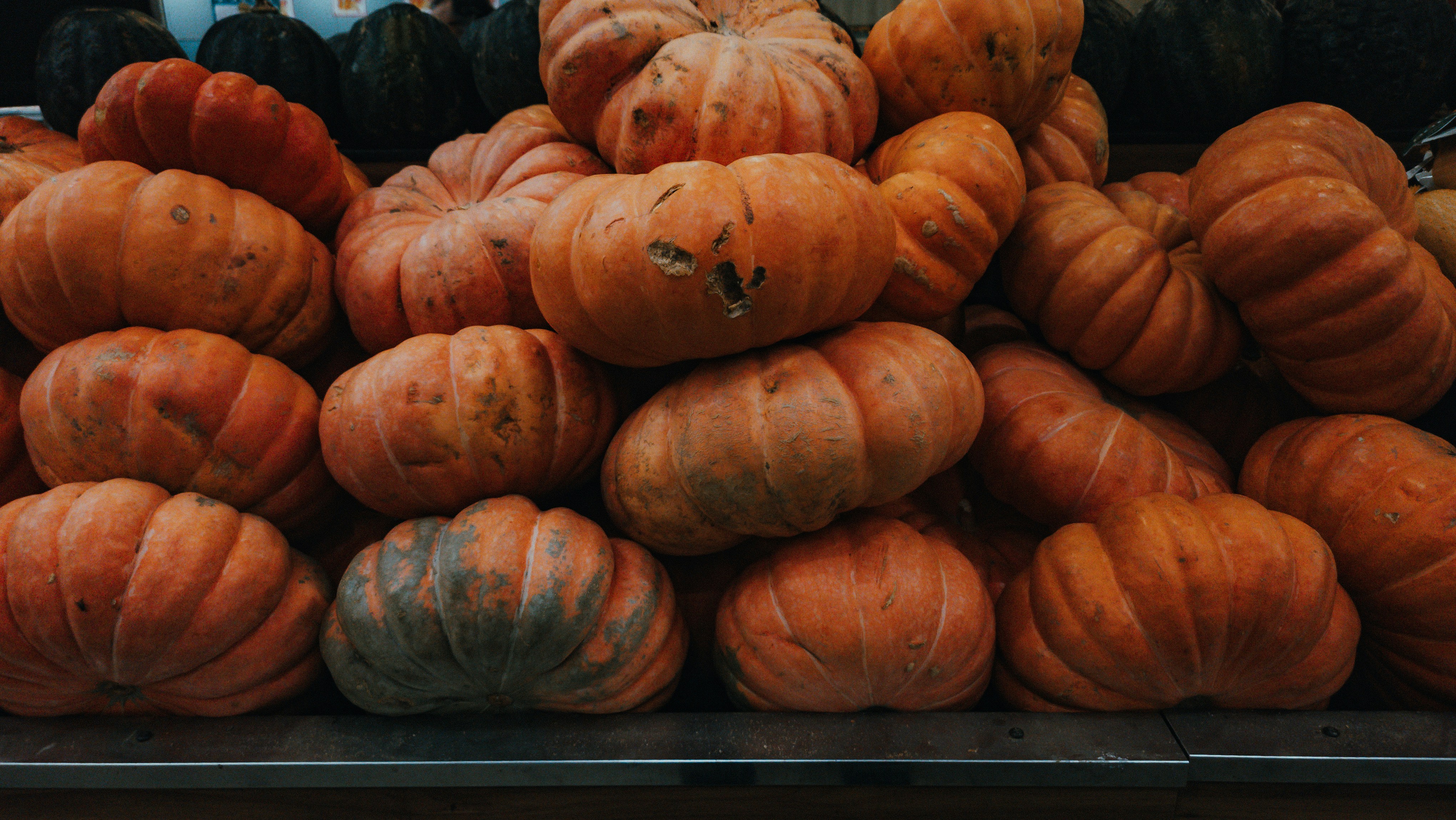 Stacked Orange Gourds: A Market Display of Season’s Harvest