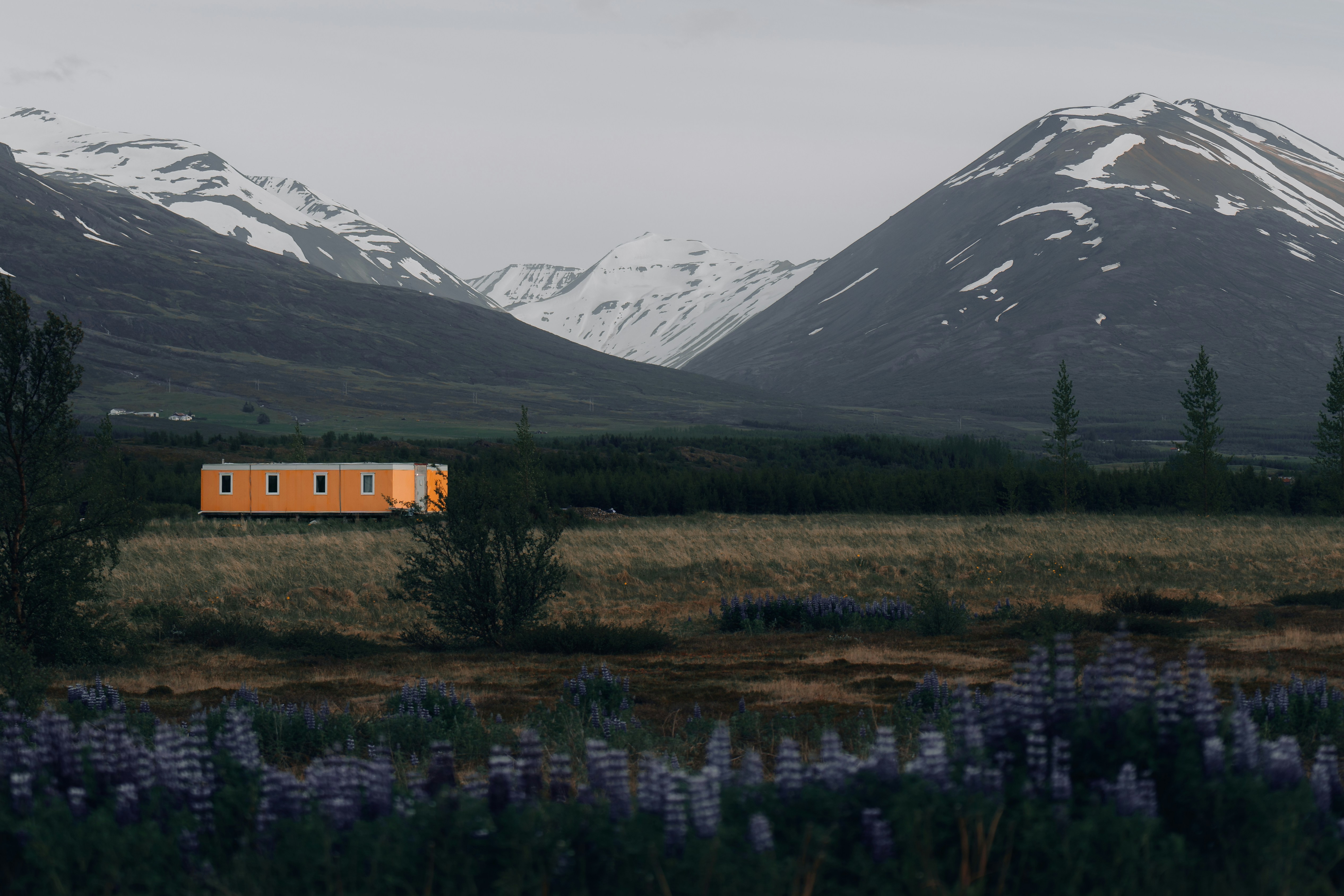 Orange Carriage in a Snowy Mountain Valley