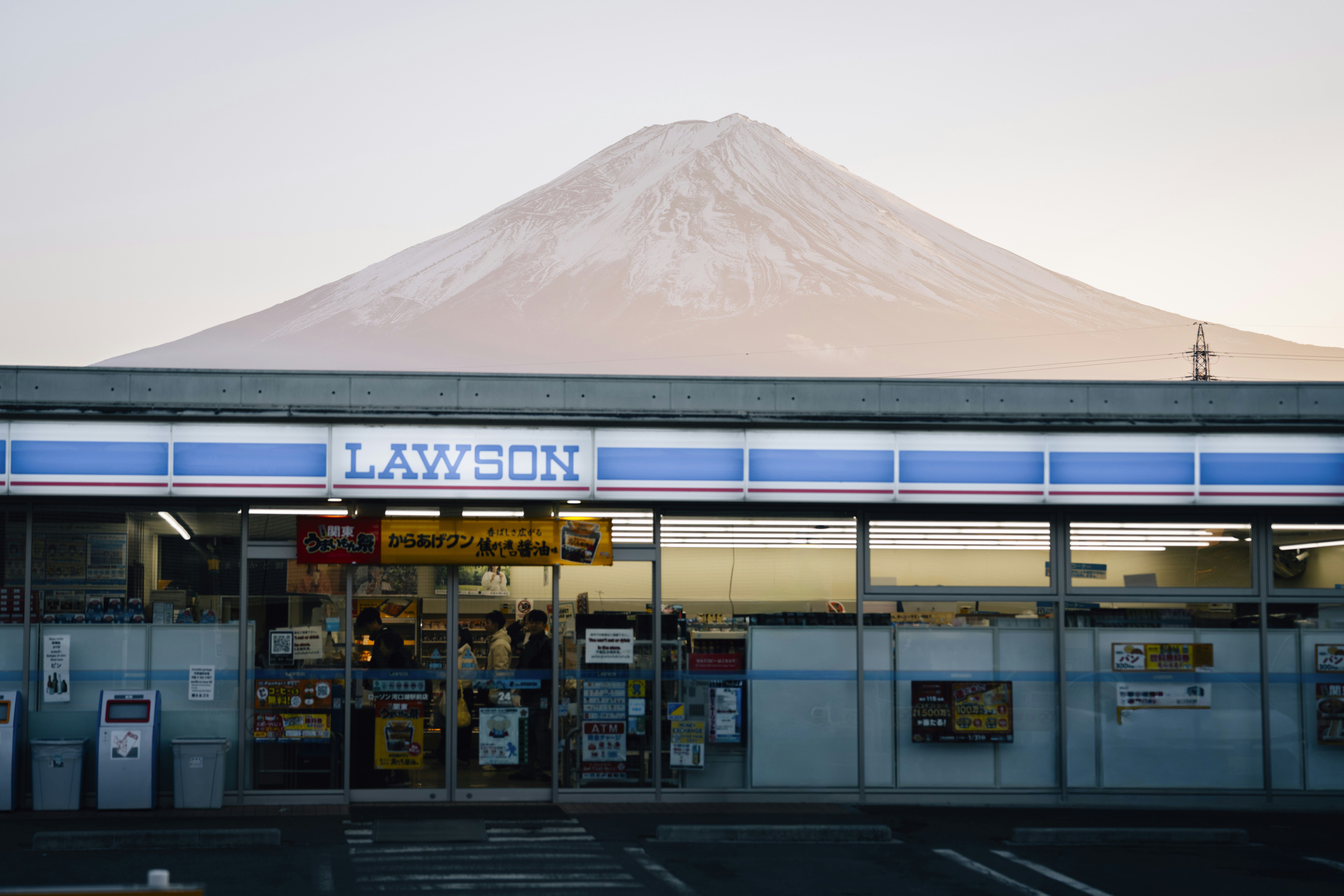 Snow-capped Summit over a Quiet Lawson: A Japanese Convenience Corner