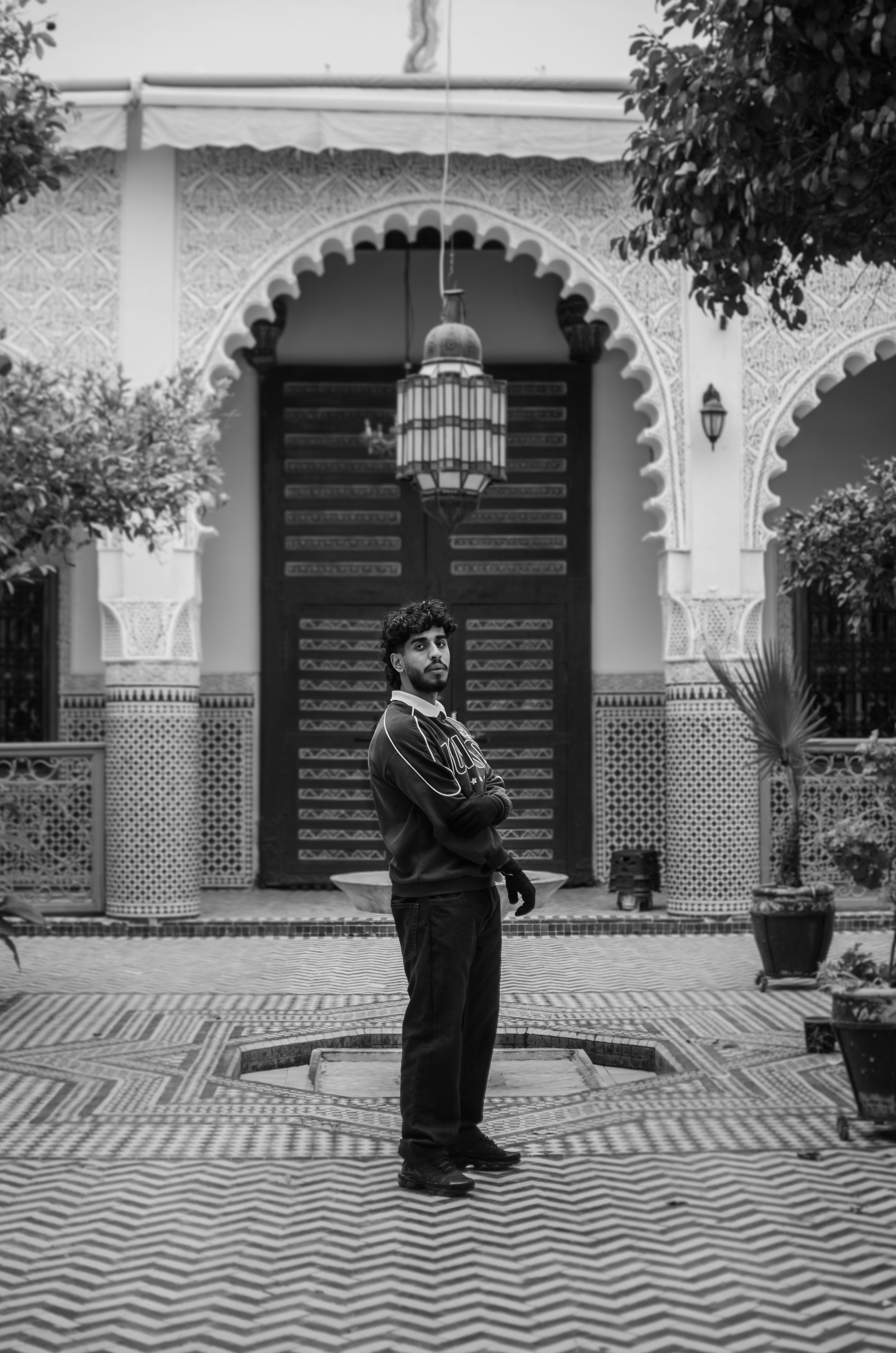 Center Stage in an Archway: A Portrait Beneath a Gentle Lantern