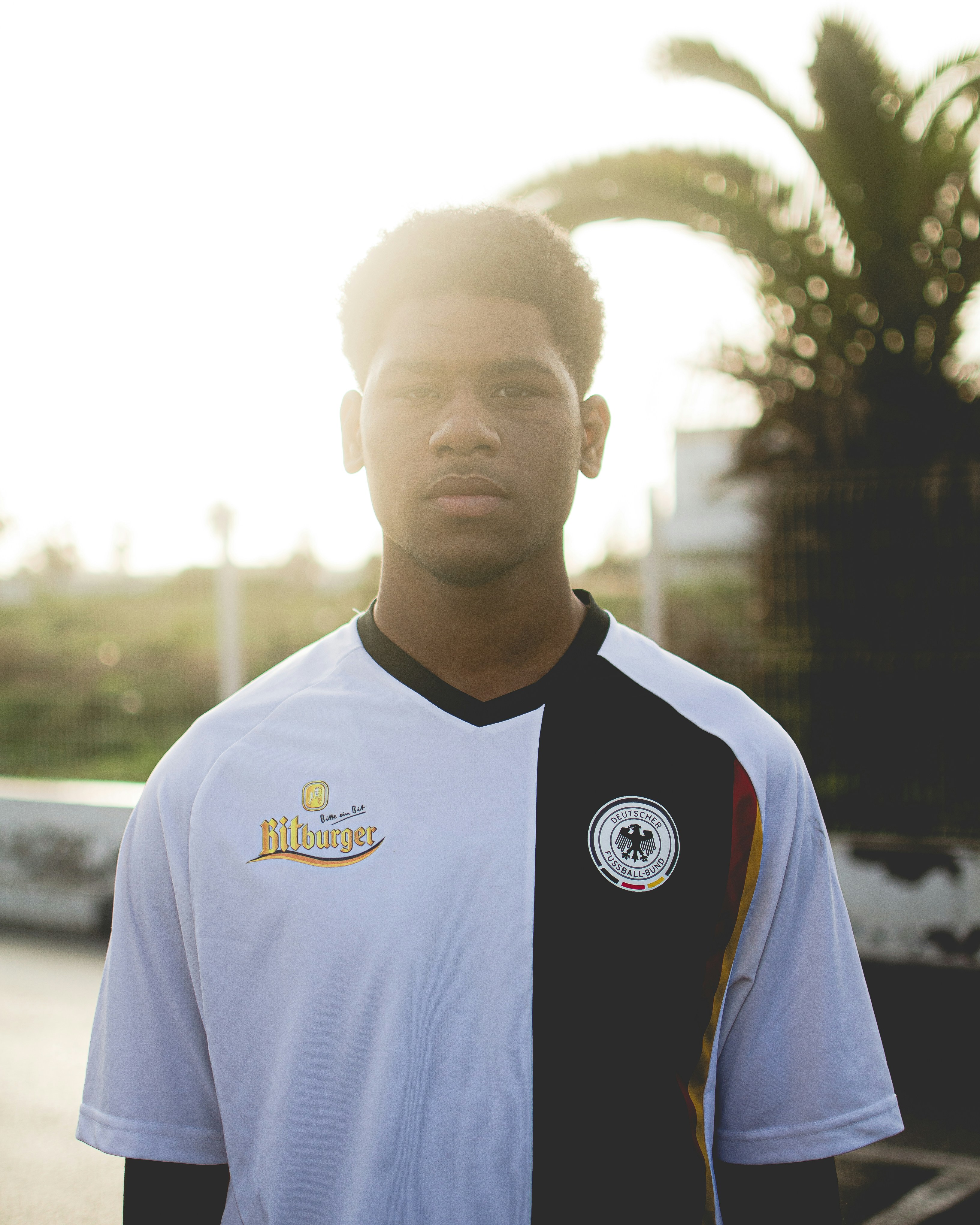 Backlit Portrait in Soft Dawn with German Football Crest