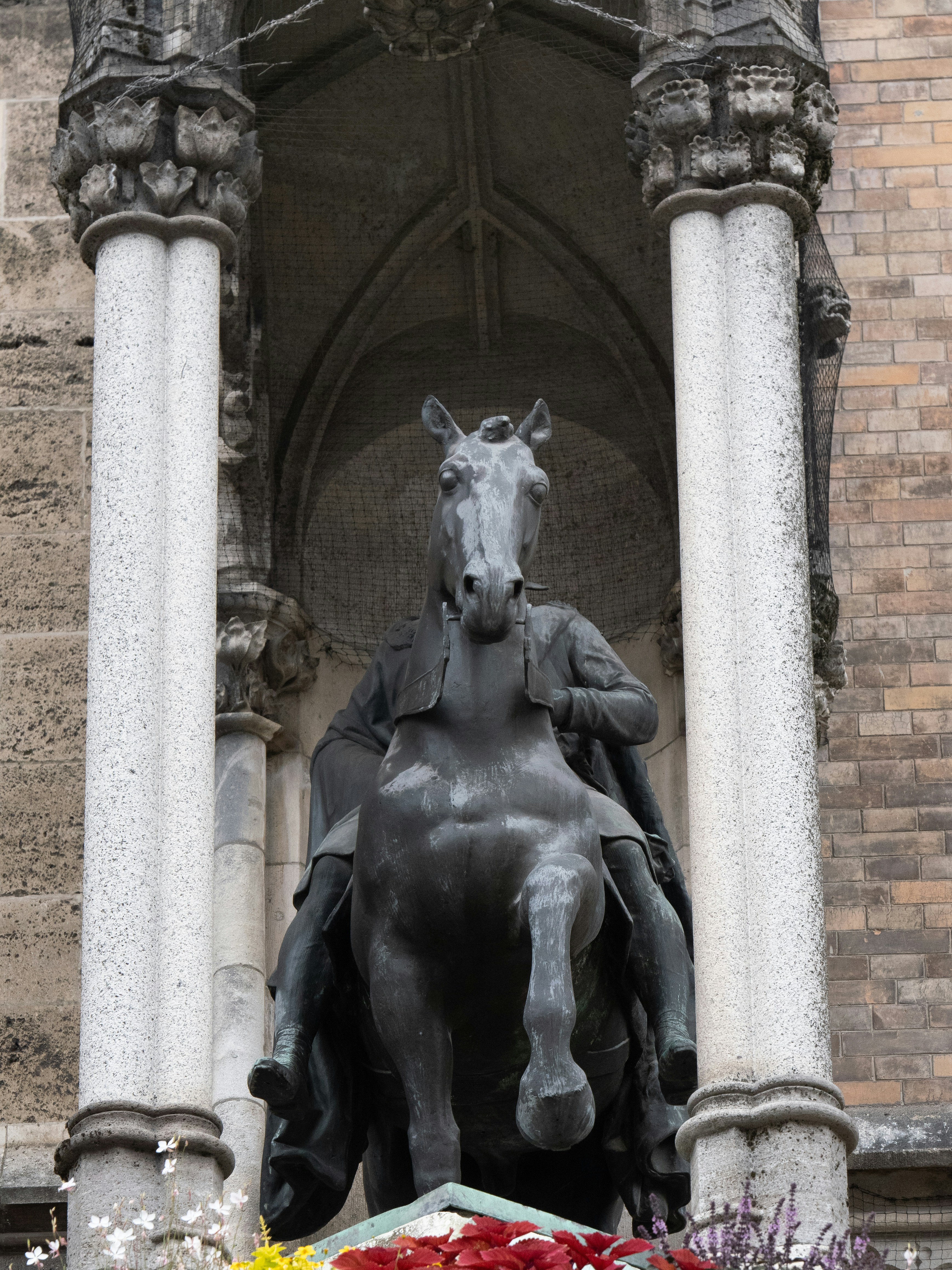 Equestrian Sentinel: A Horse and Rider Framed by Stone Columns