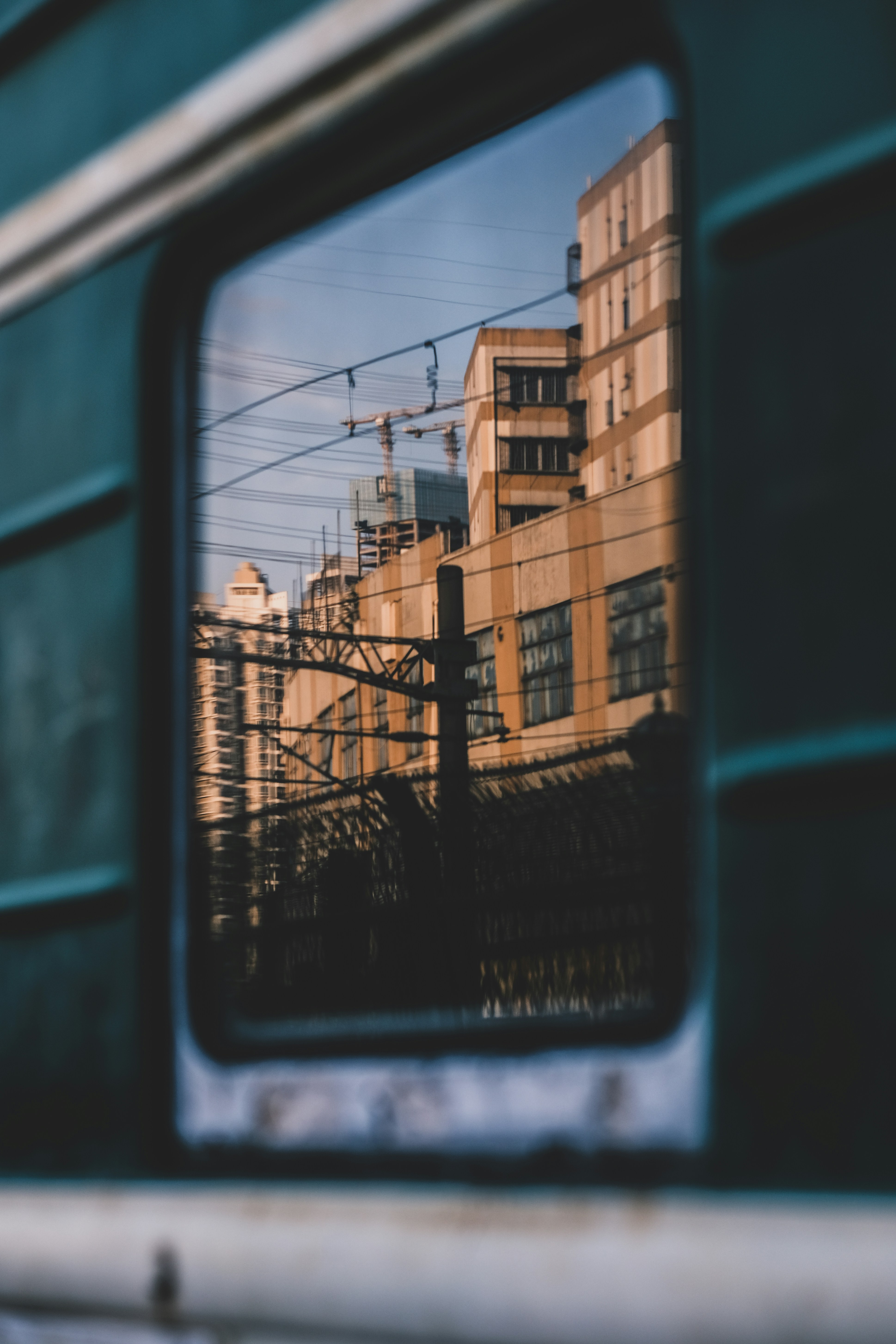 Urban Reflections: Train Window Vista of Blocky Golden Facades