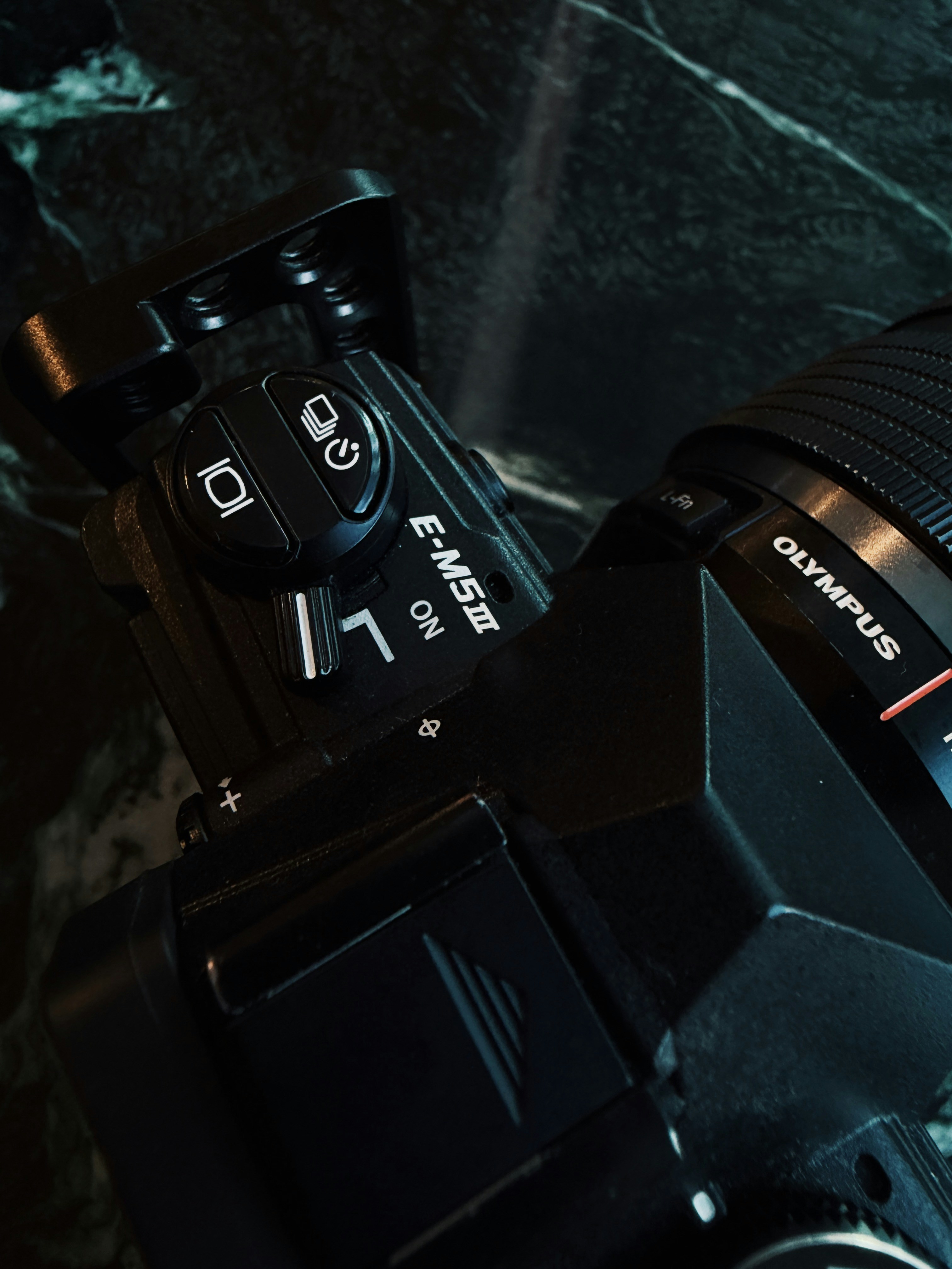 Close-Up of a Vintage-Style DSLR with an Olympus Lens