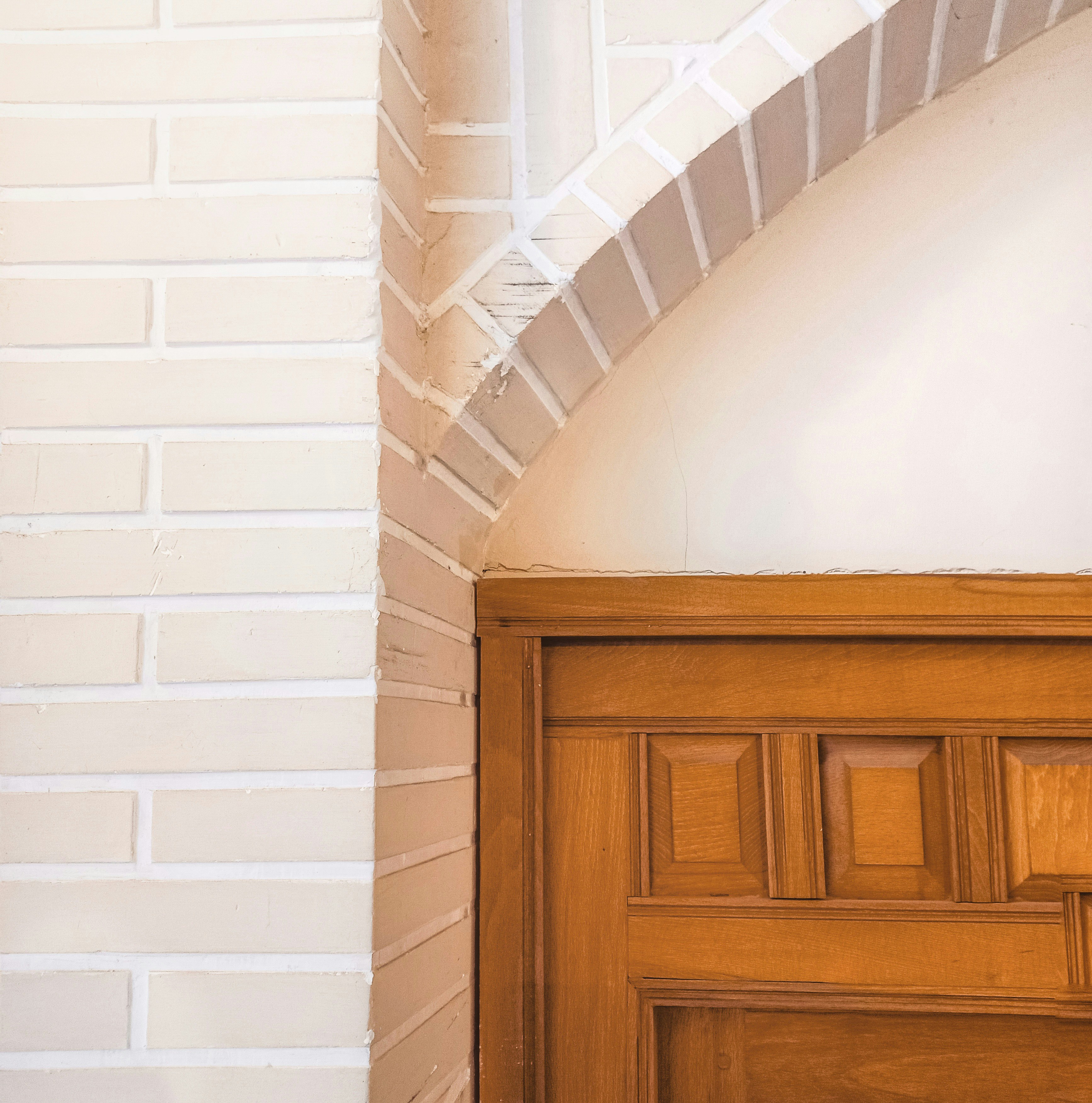 Arched Brickwork Framing a Solid Wooden Door