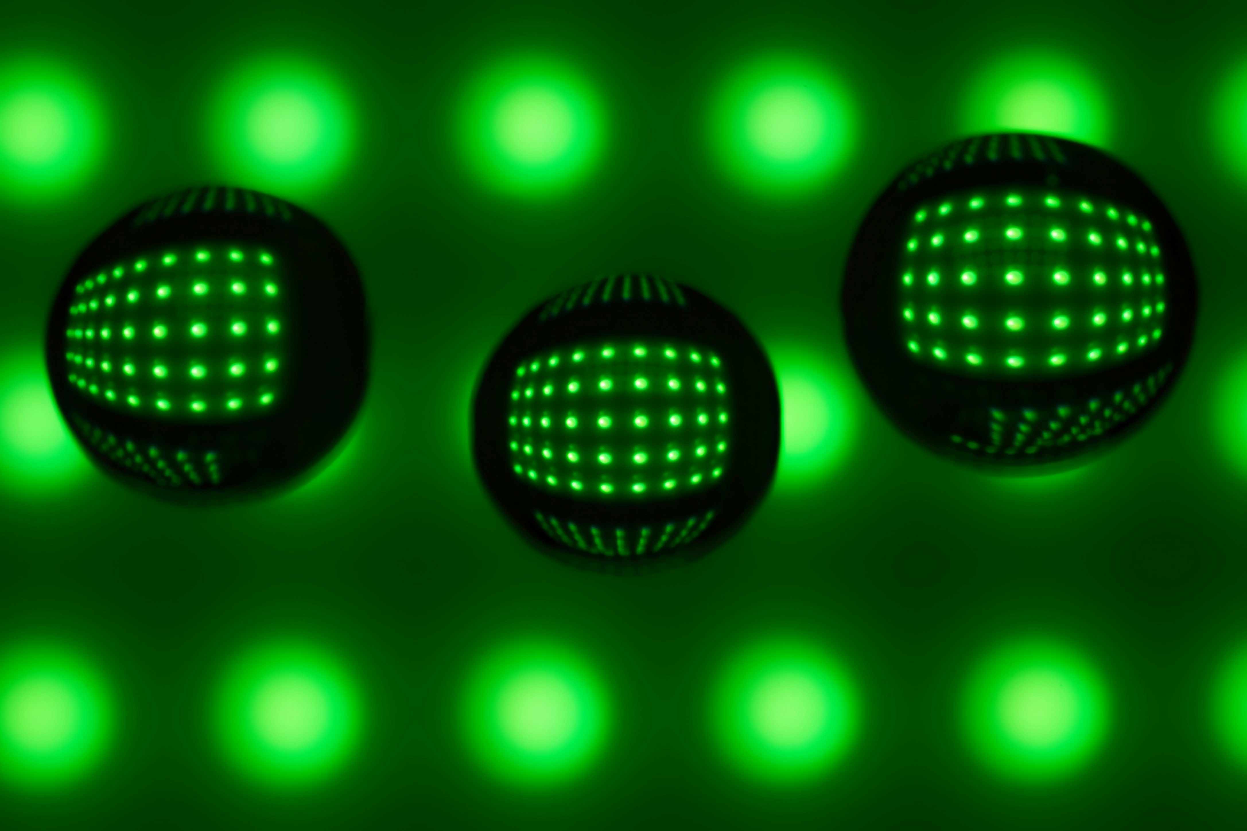 Three Neon Orbs: A Macro Dance of Green Gridlights