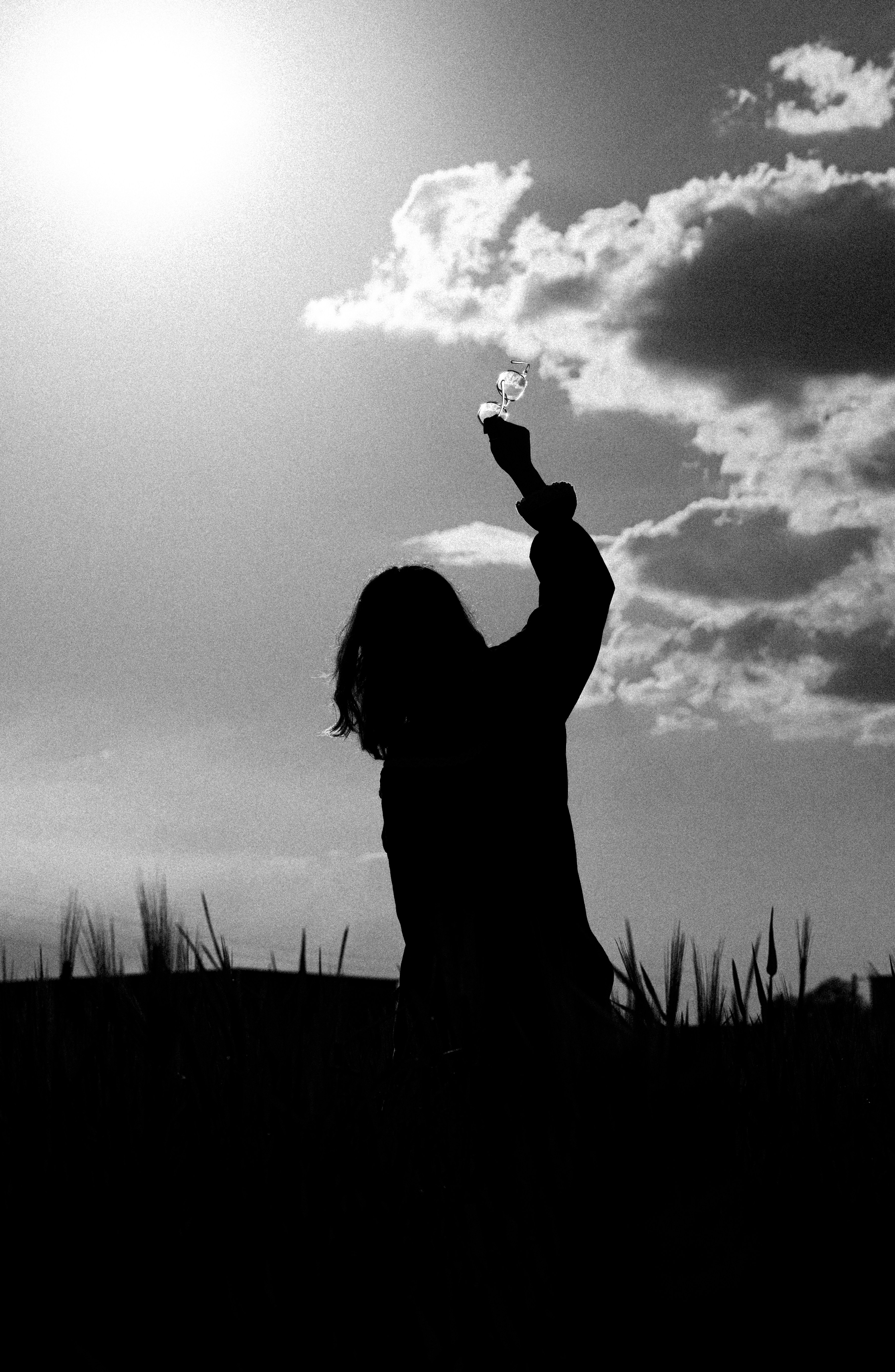 Silhouette Triumph: Raising a Small Flame Against a Vast Sky