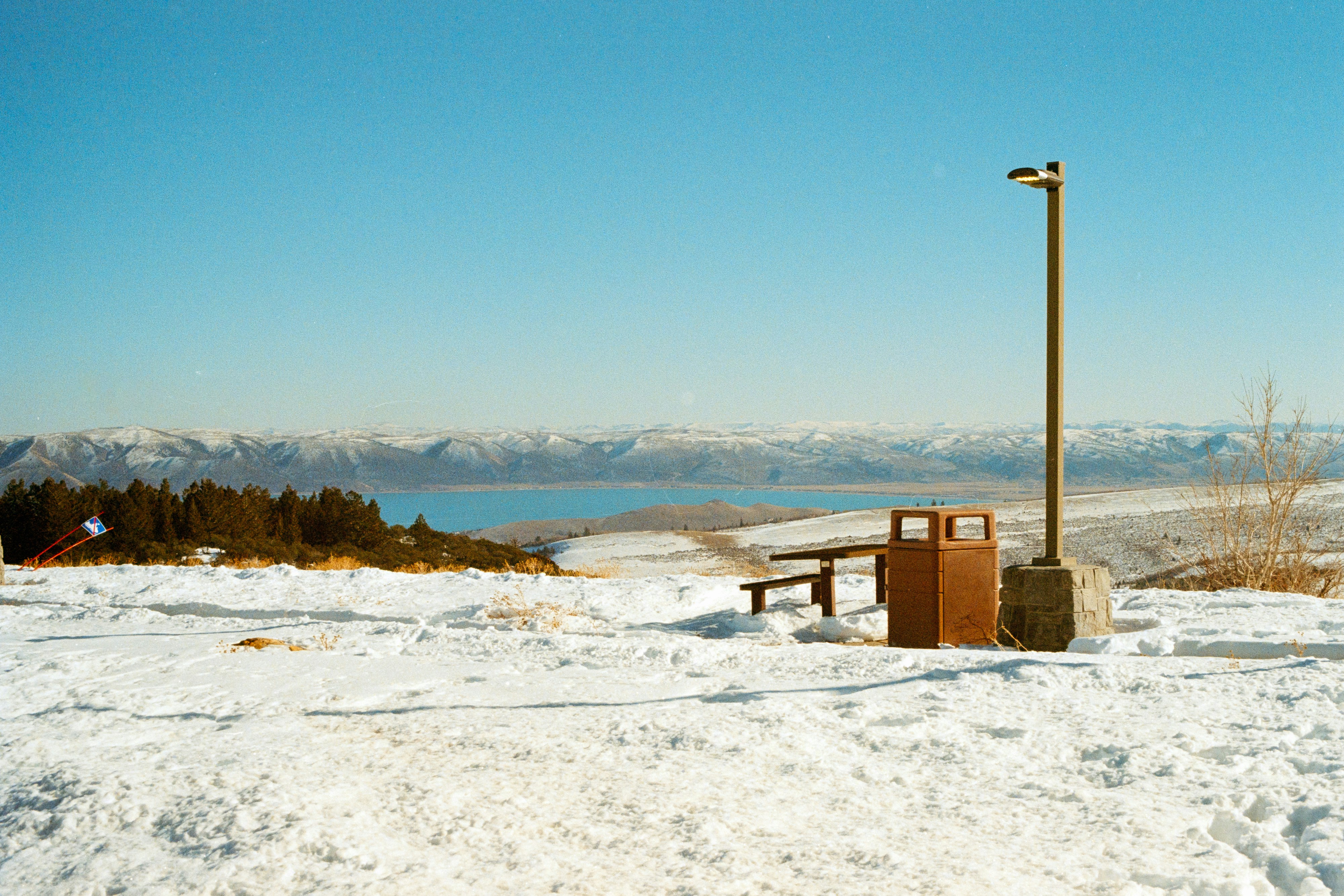 Snowbound Vista with Lone Lighthouse and Bench