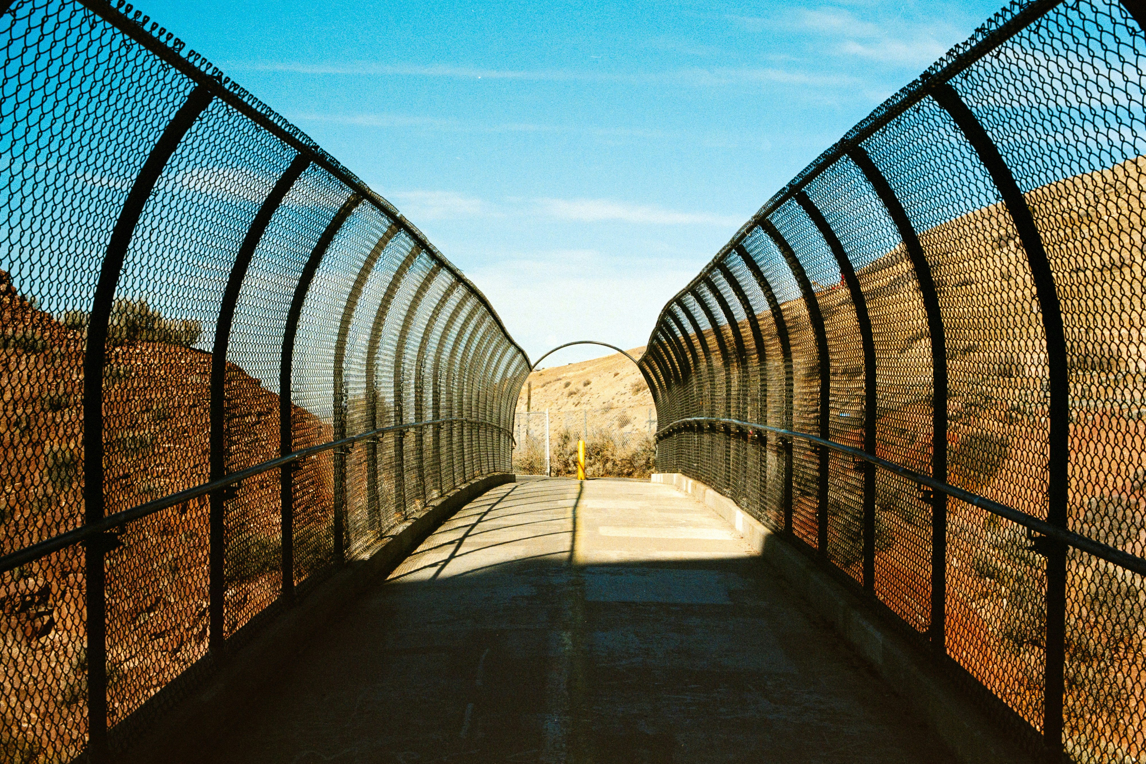 Light at the End: A Shelter Tunnel Framed by Curved Fences