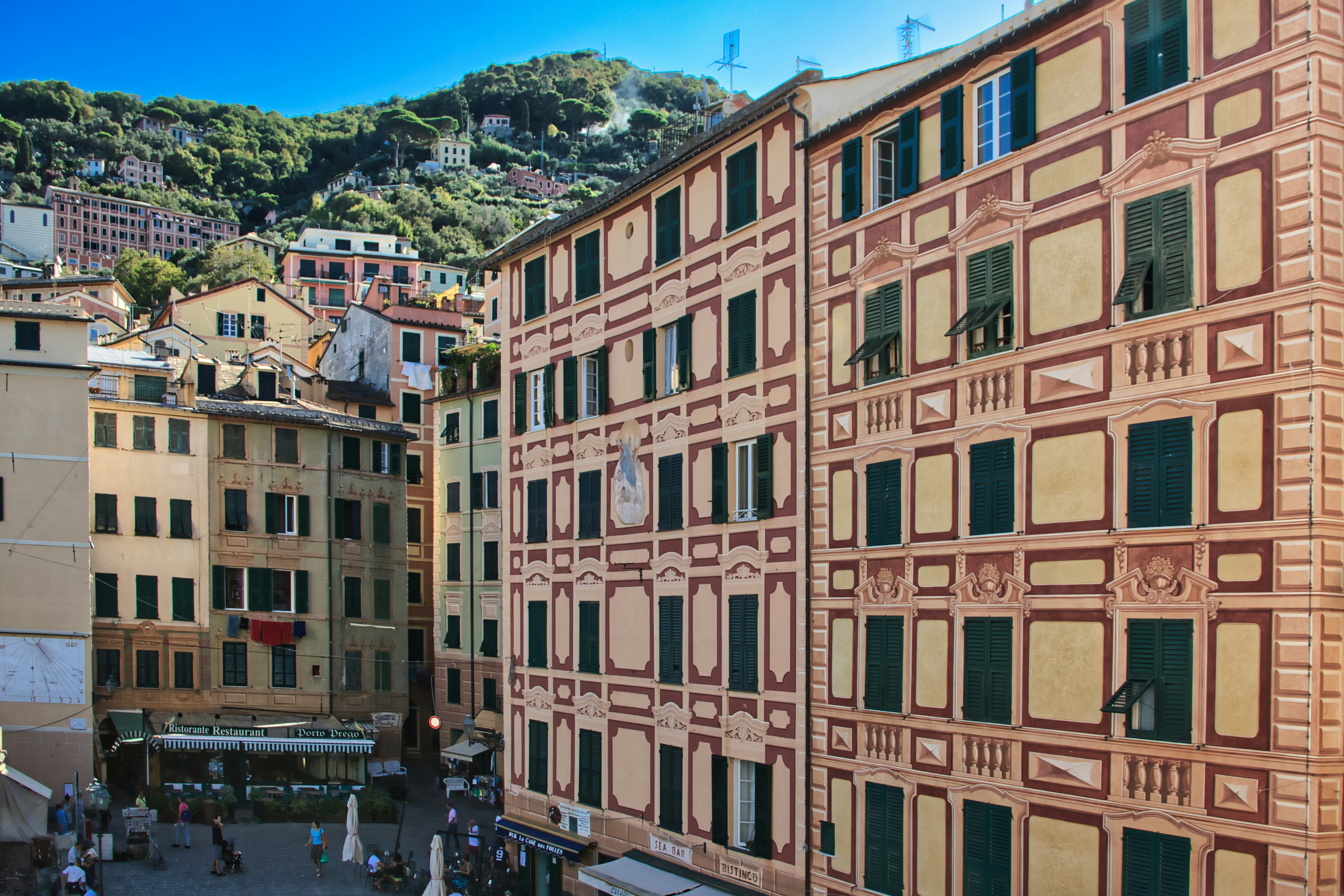 Colorful Italian Facade Portraits Towering Over a Sunlit Piazza