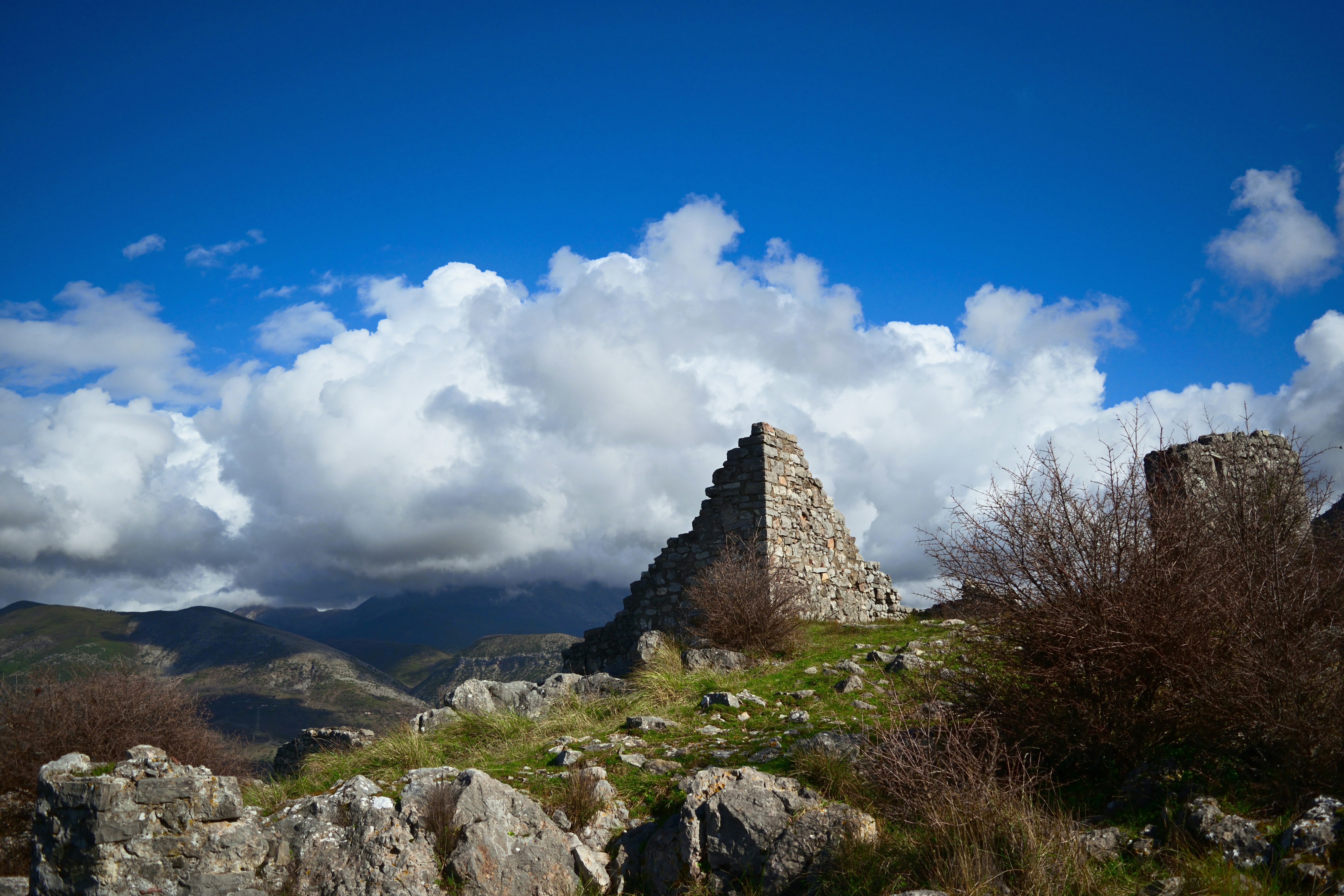 Ancient Stone Ruin Standing Against a Sky-lined Ridge