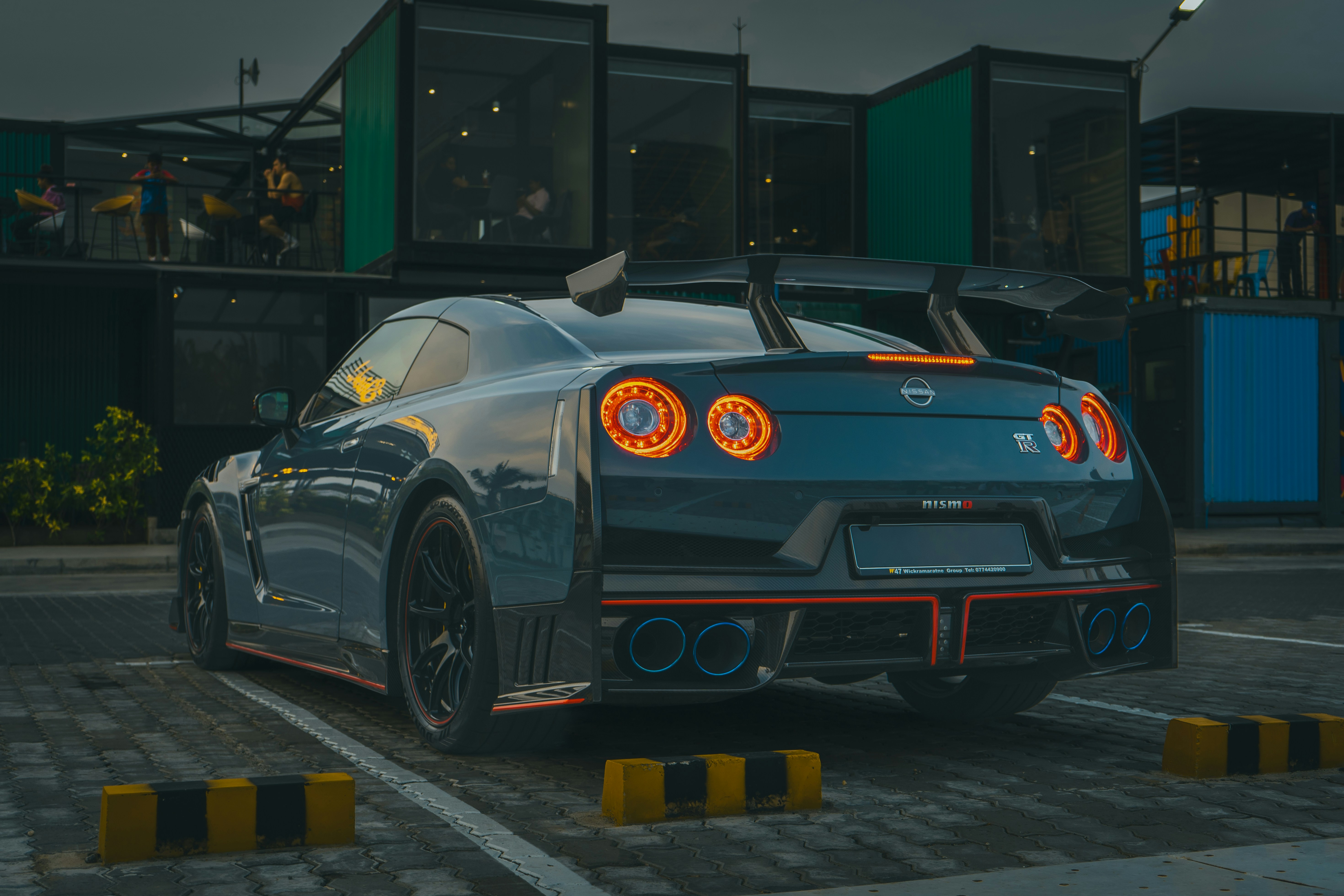 Rear View Skyline: A blue Nissan GT-R Stands Bold in Neon-Trim Parking