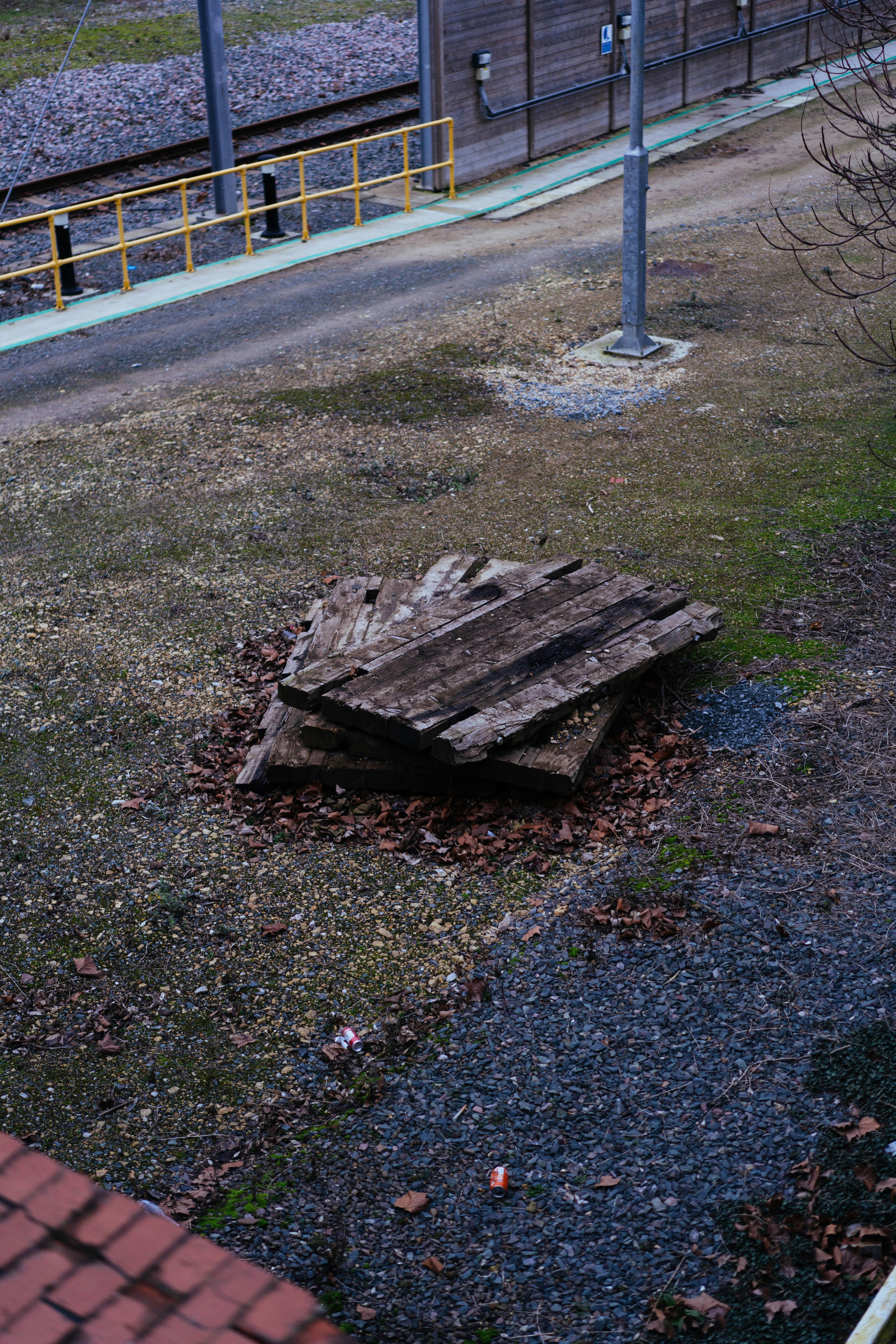 Weathered lumber on a vacant lot near a rail yard