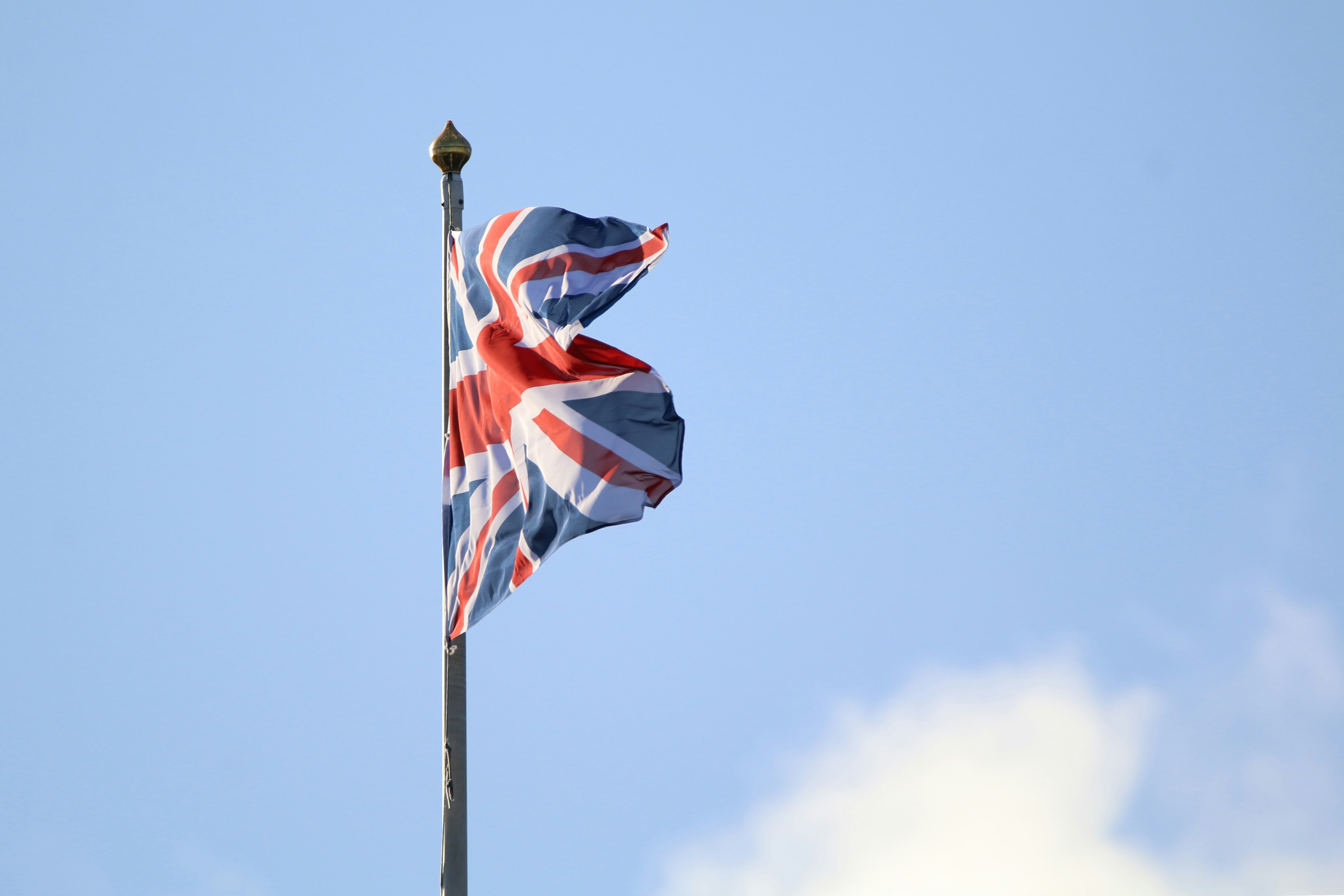 Flag on a Tall Pole Against a Clear Sky
