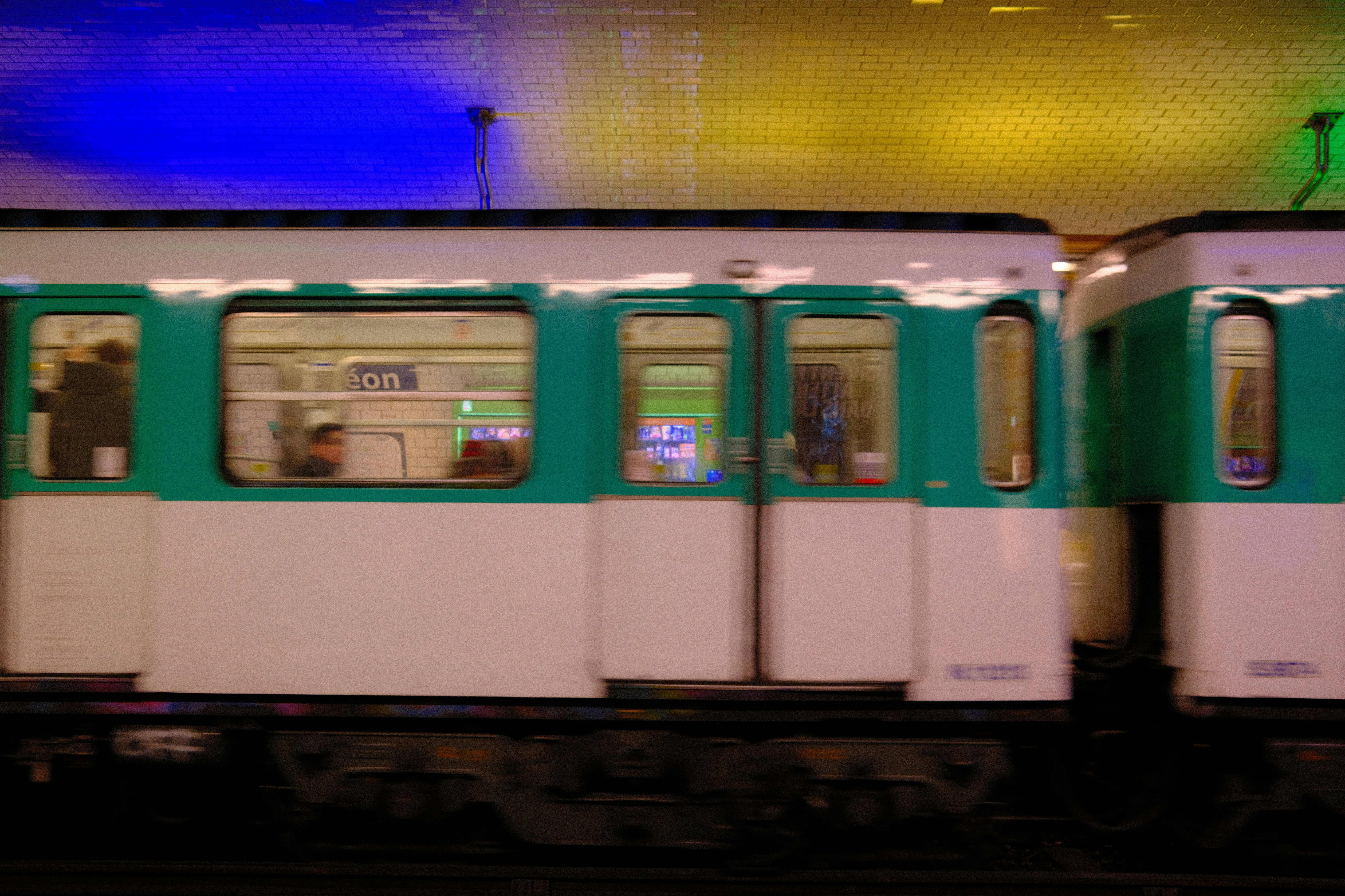 Motion Blur at a Metro Stop: Green Car Trains in a Night Scene