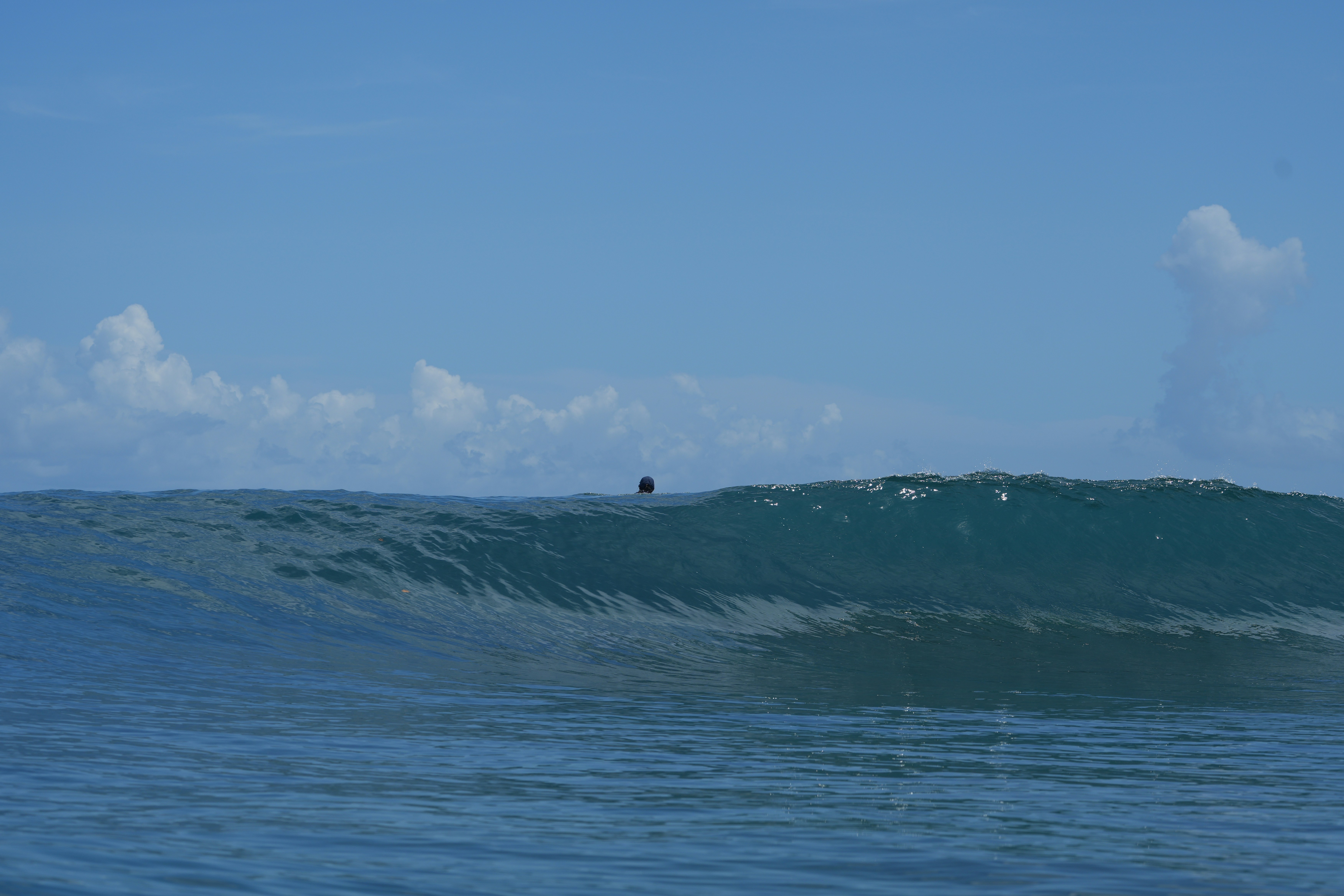 Isolated Wave Crest Beneath a Calm Sky