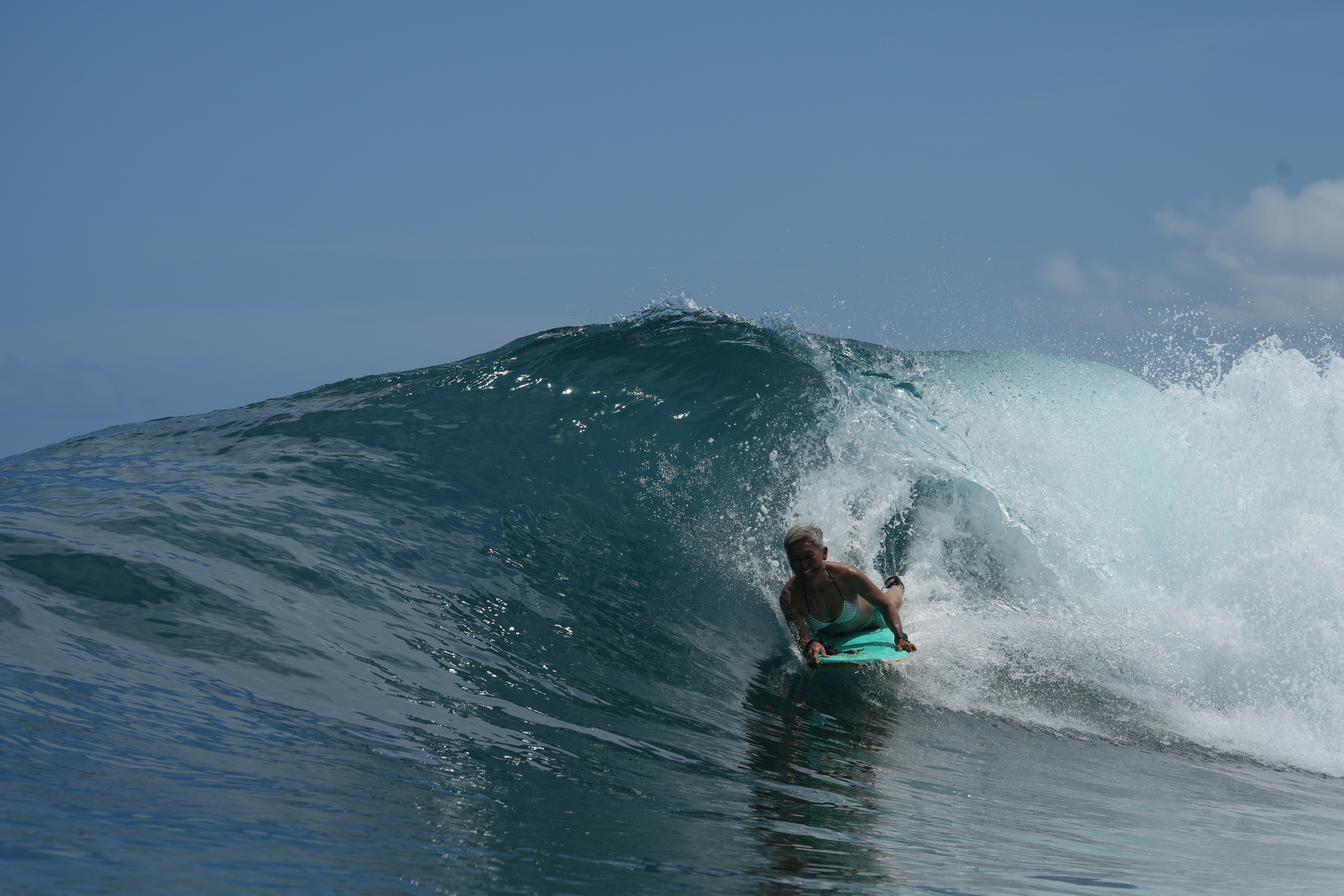 Green Crest: Surfer Carving a Barrel