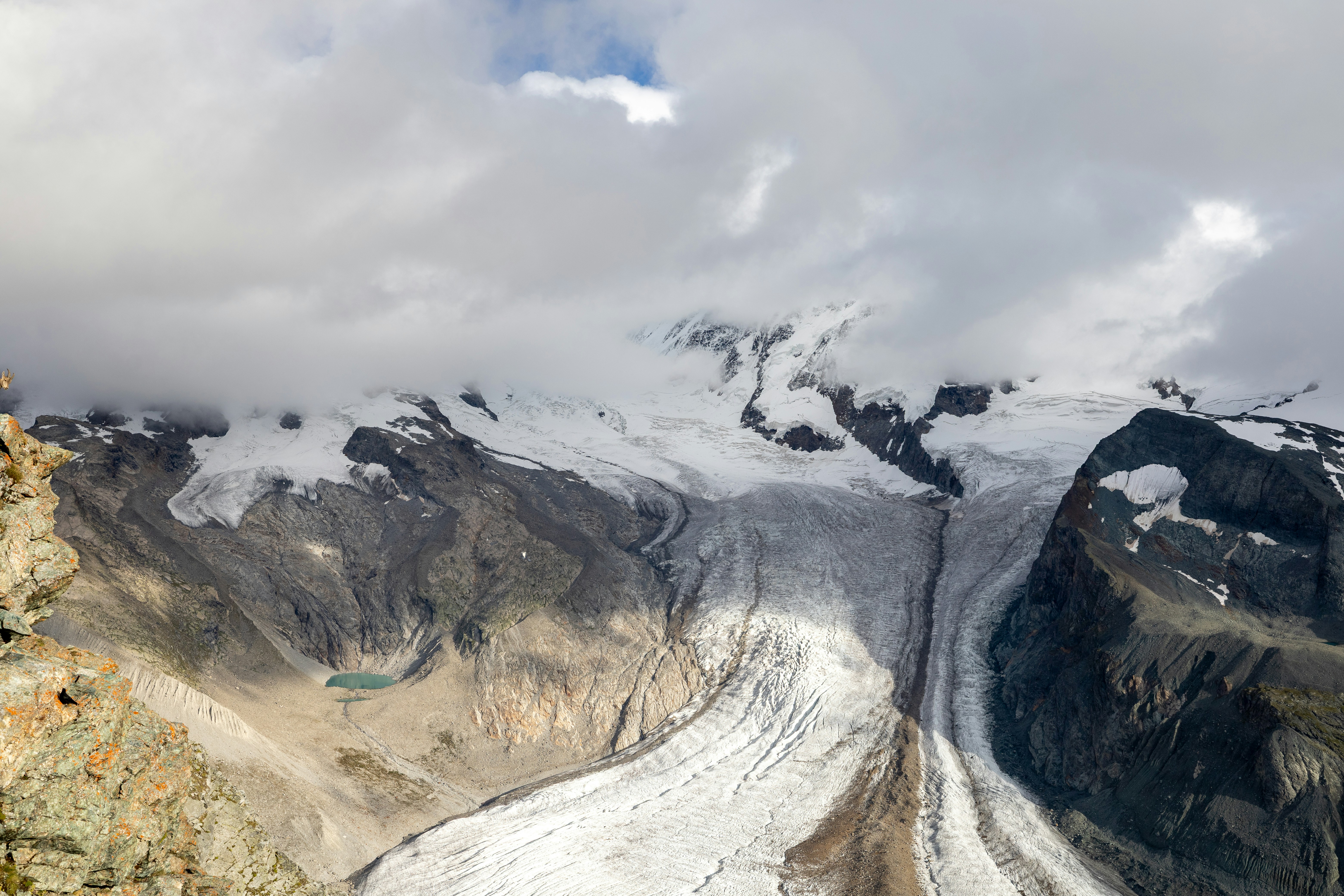 Glacial Crescendo: A Snowfield Woven Between Dark Ridge Lines